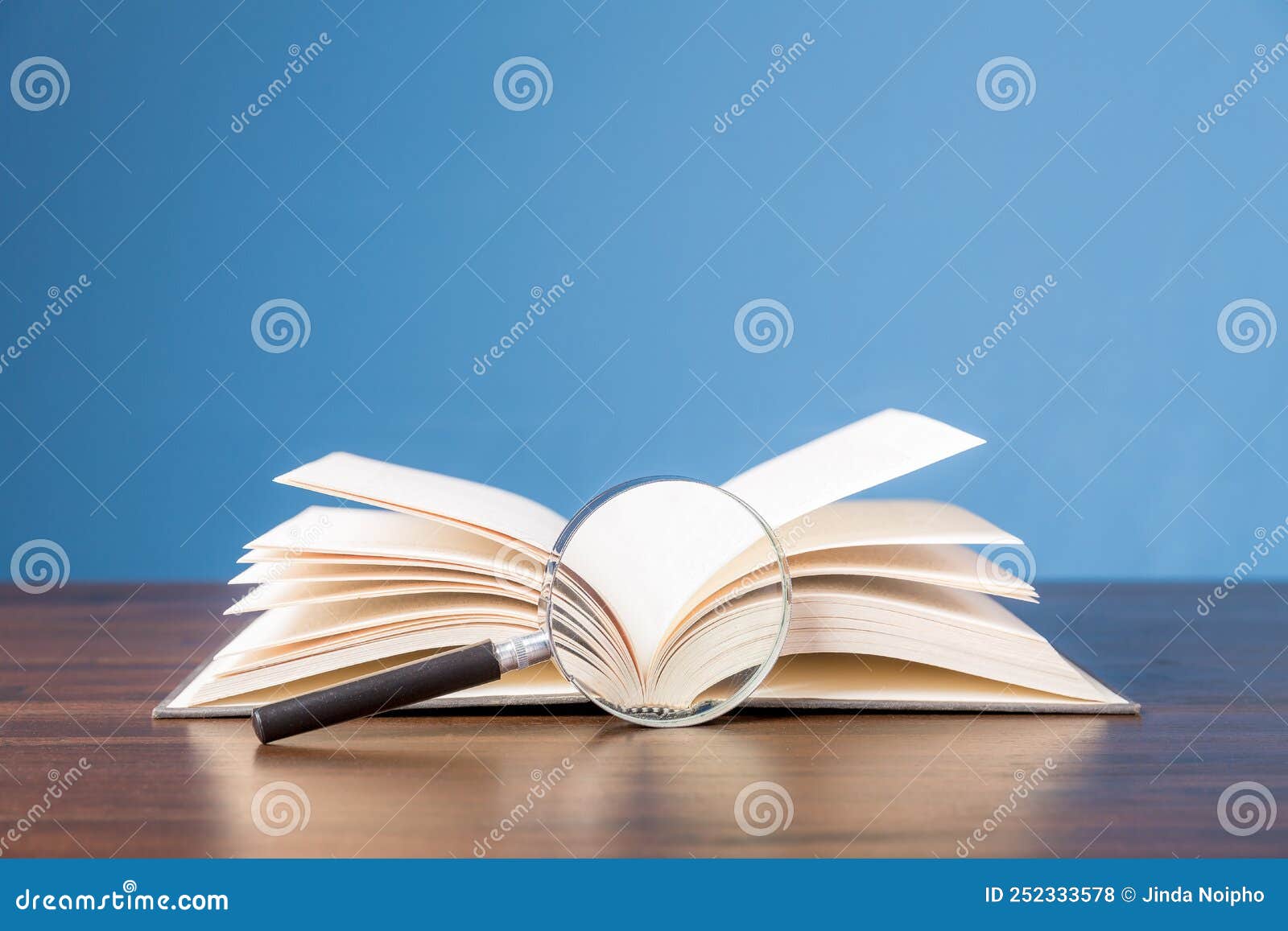 Open Book With Magnifying Glass On Wooden Desk In Information Library Of School Or University