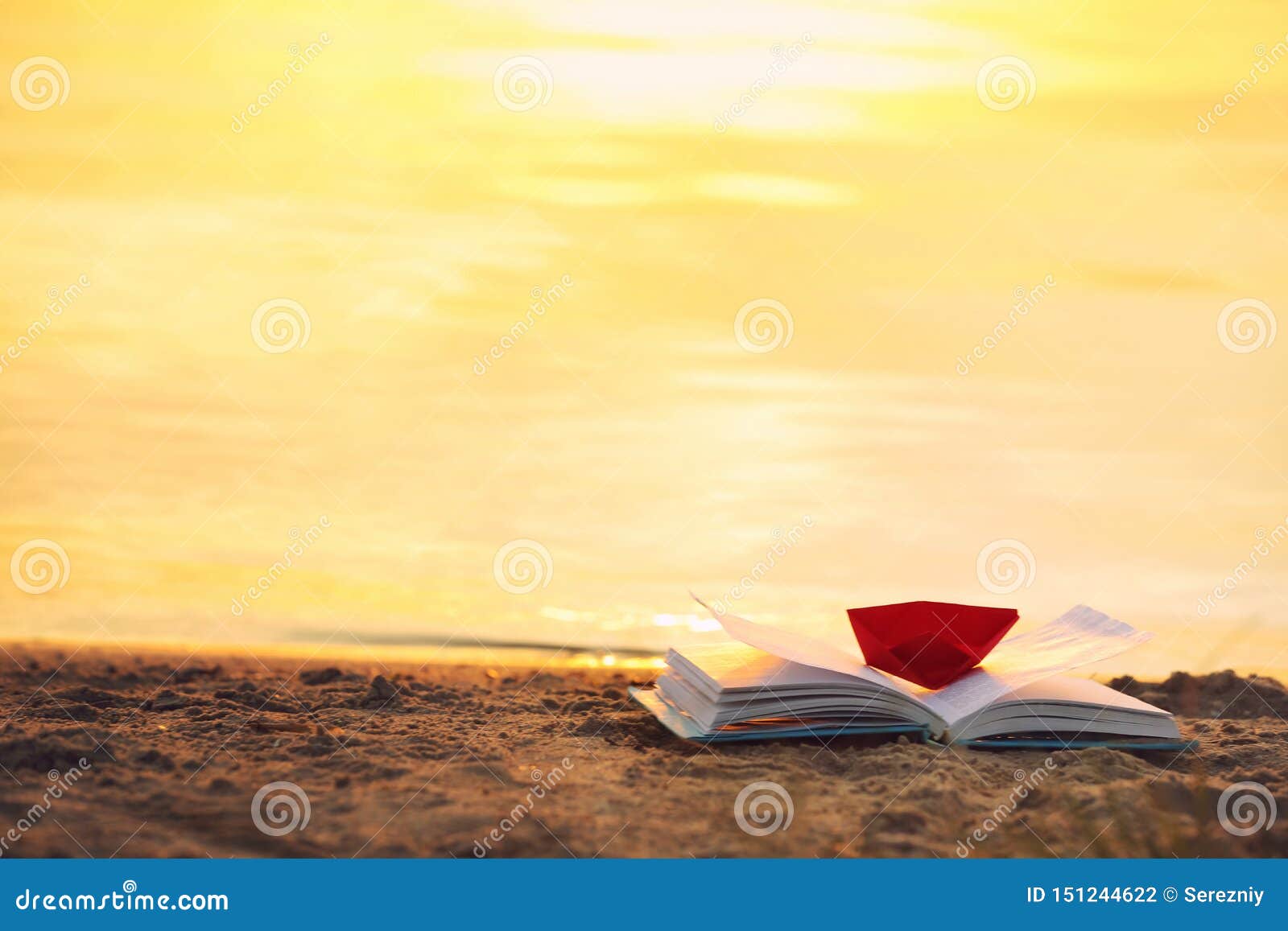 Open Book with Origami Boat on Beach Stock Photo - Image of color, bank ...