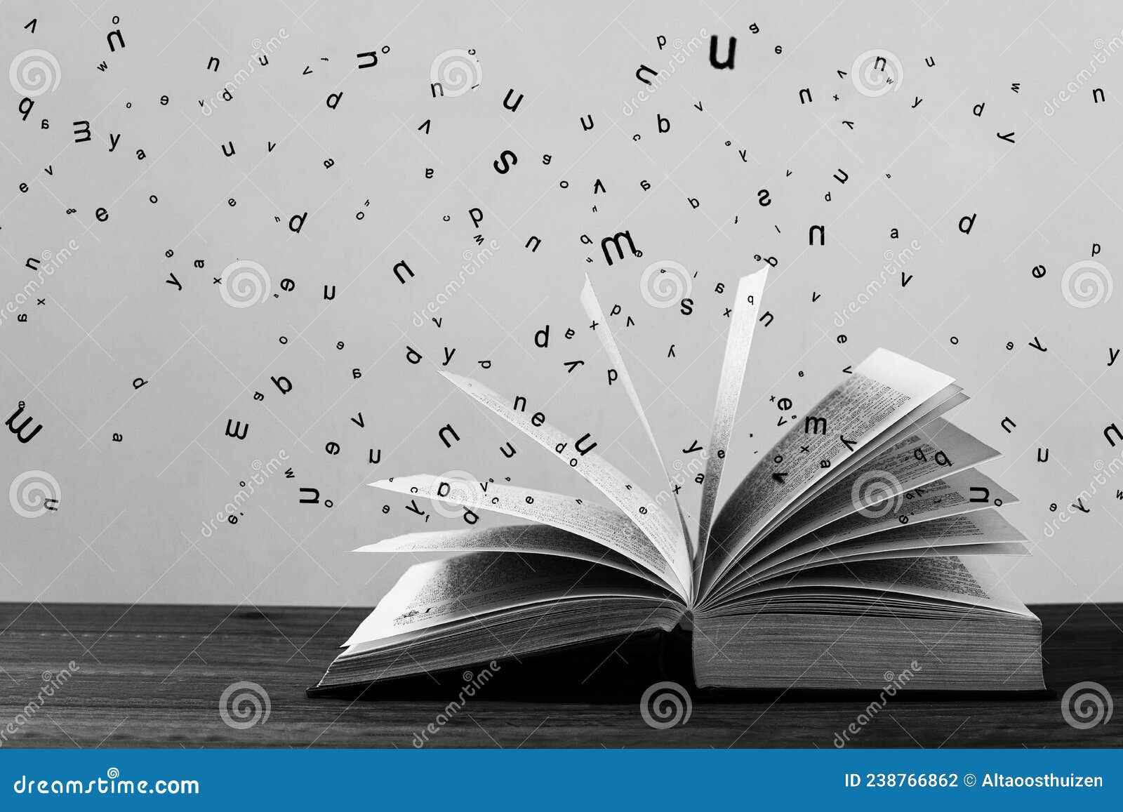 Open Book Spilling Out Letters into Its Surroundings Stock Photo ...
