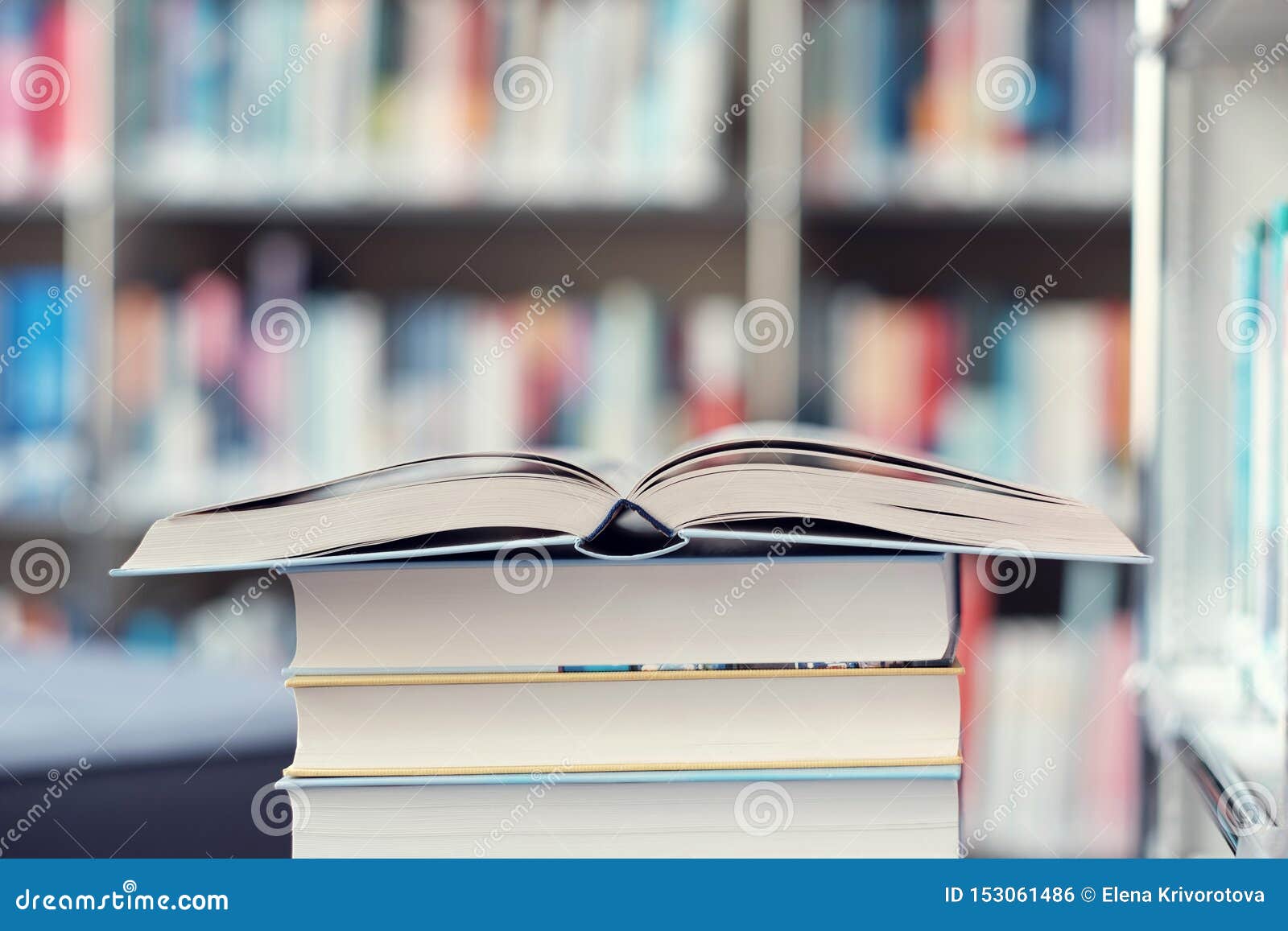Open Book on a Stack of Books in a Library Stock Photo - Image of ...
