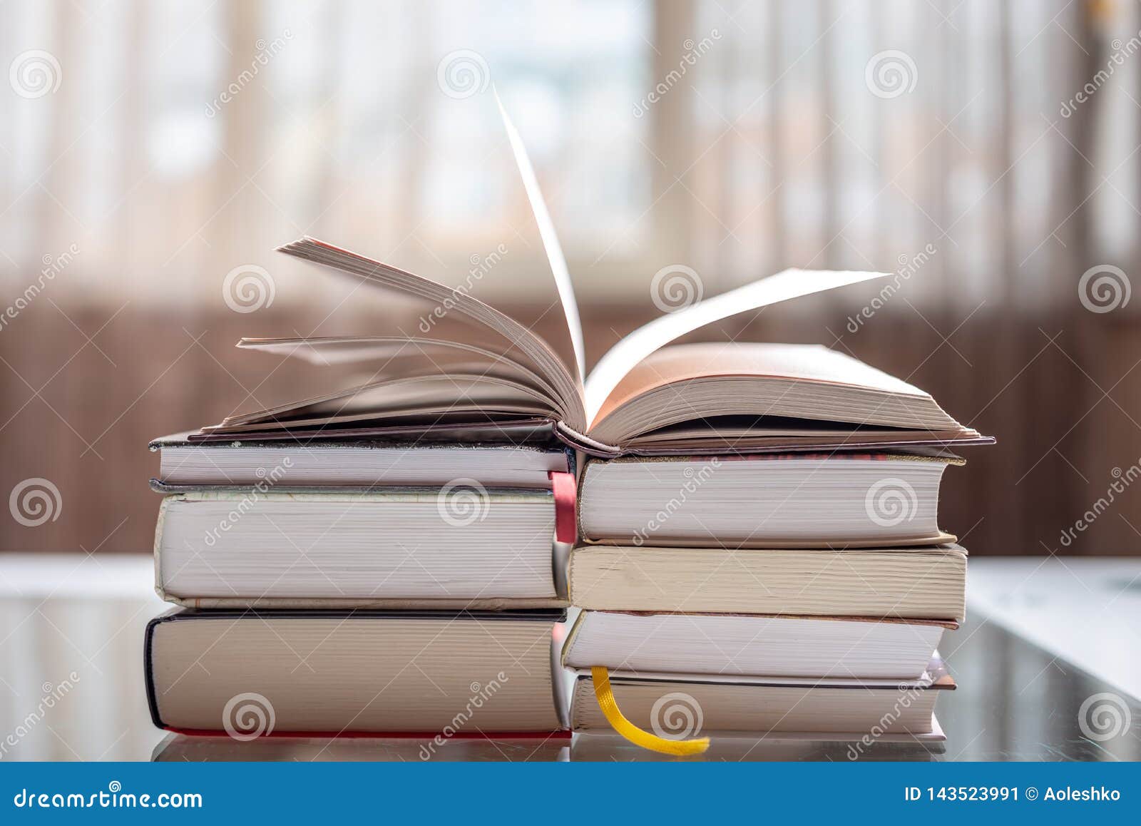 Open Book on a Stack of Books on a Table in a Bright Room. Education ...