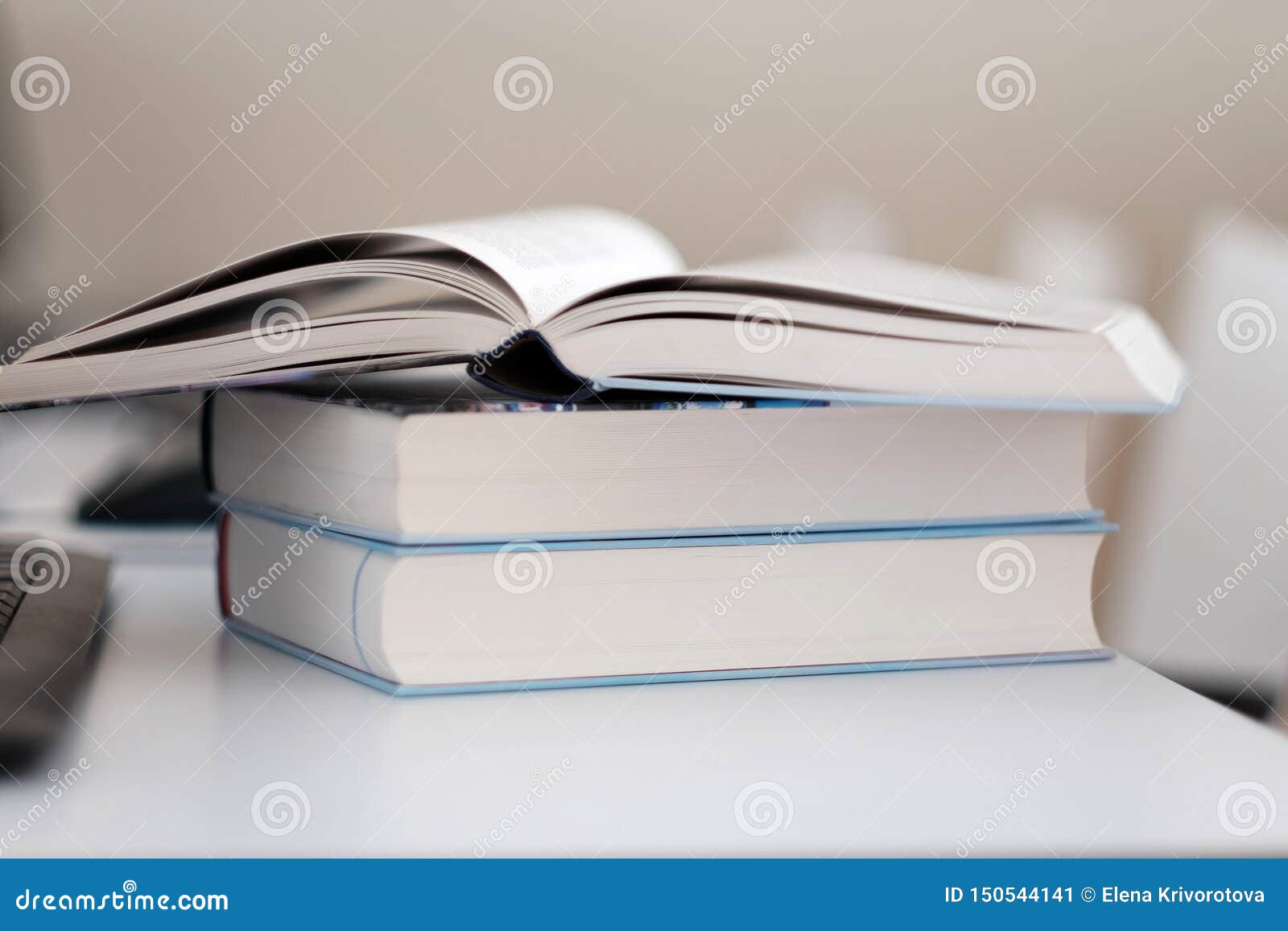 Open Book on a Stack of Books on a Table Stock Image - Image of white ...