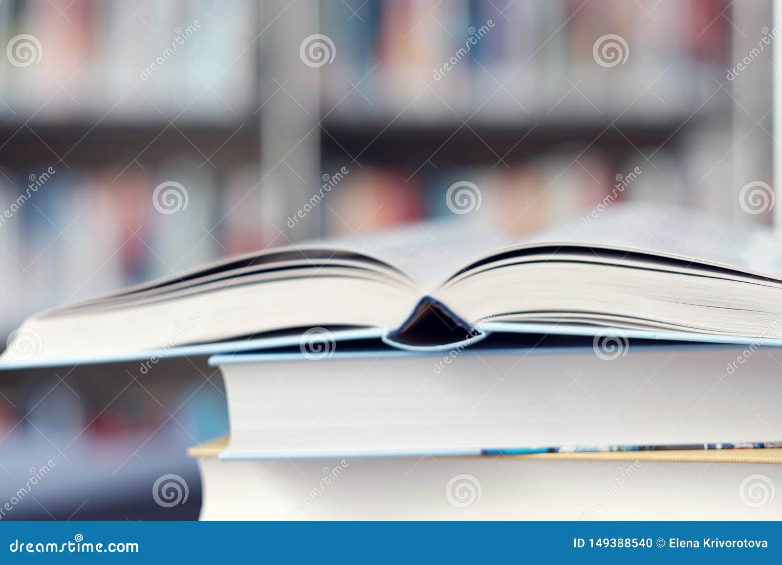 Open Book on a Stack of Books in a Library Stock Photo - Image of book ...