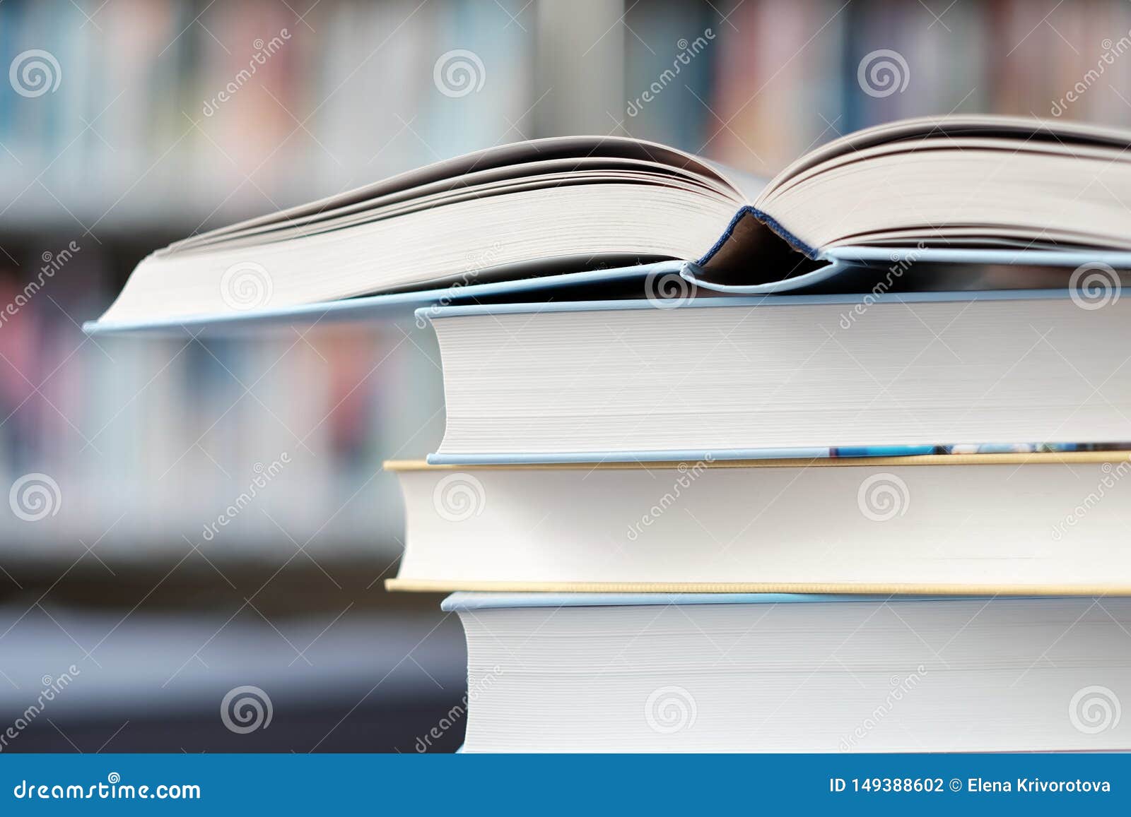 Open Book on a Stack of Books in a Library Stock Photo - Image of ...