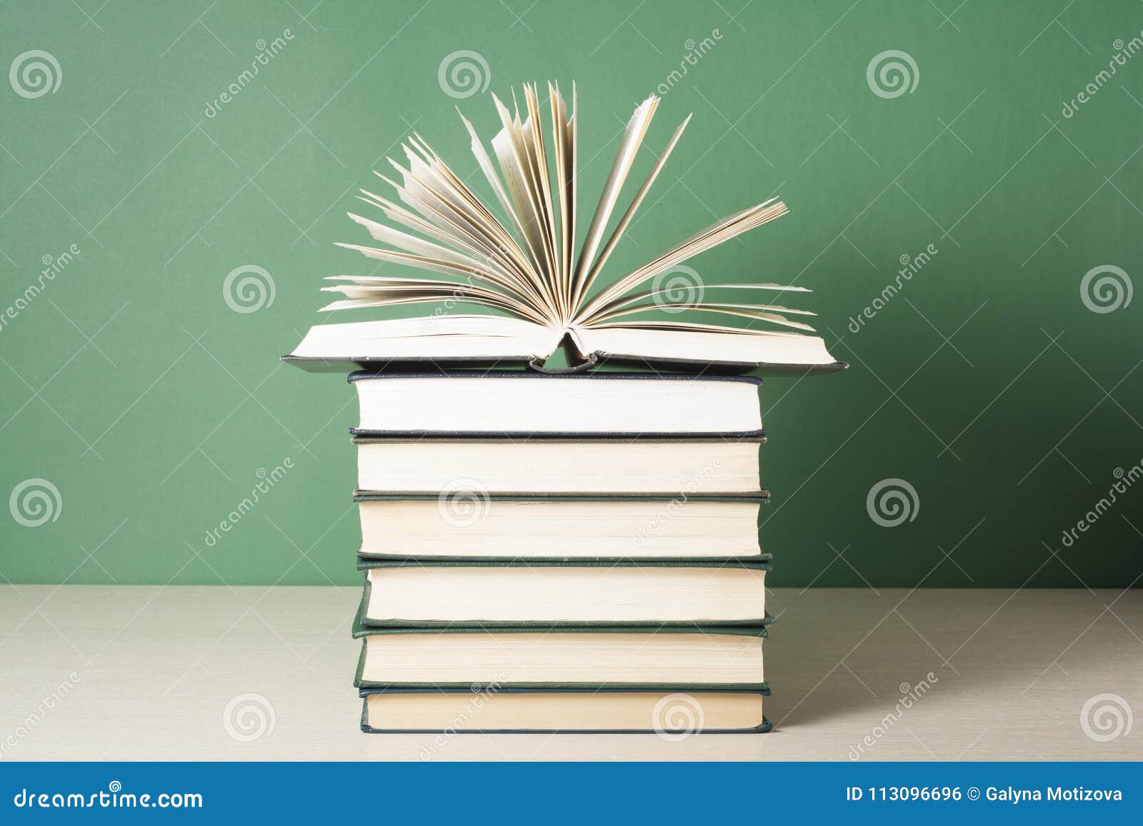 Open Book on Stack of Books on Wooden Table. Education Background. Back ...
