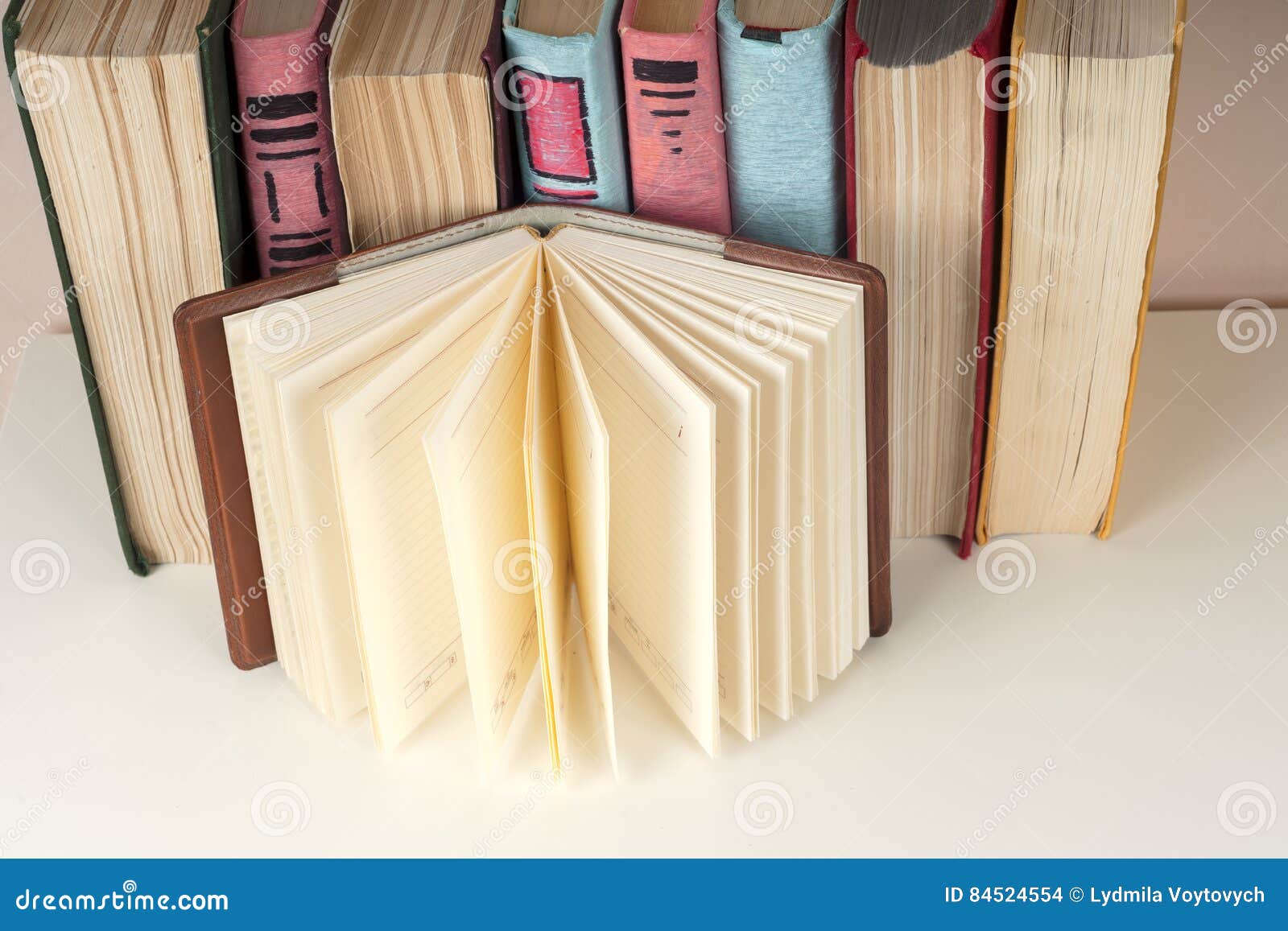 Open Book, Stack of Colorful Hardback Books on Light Table. Back To ...