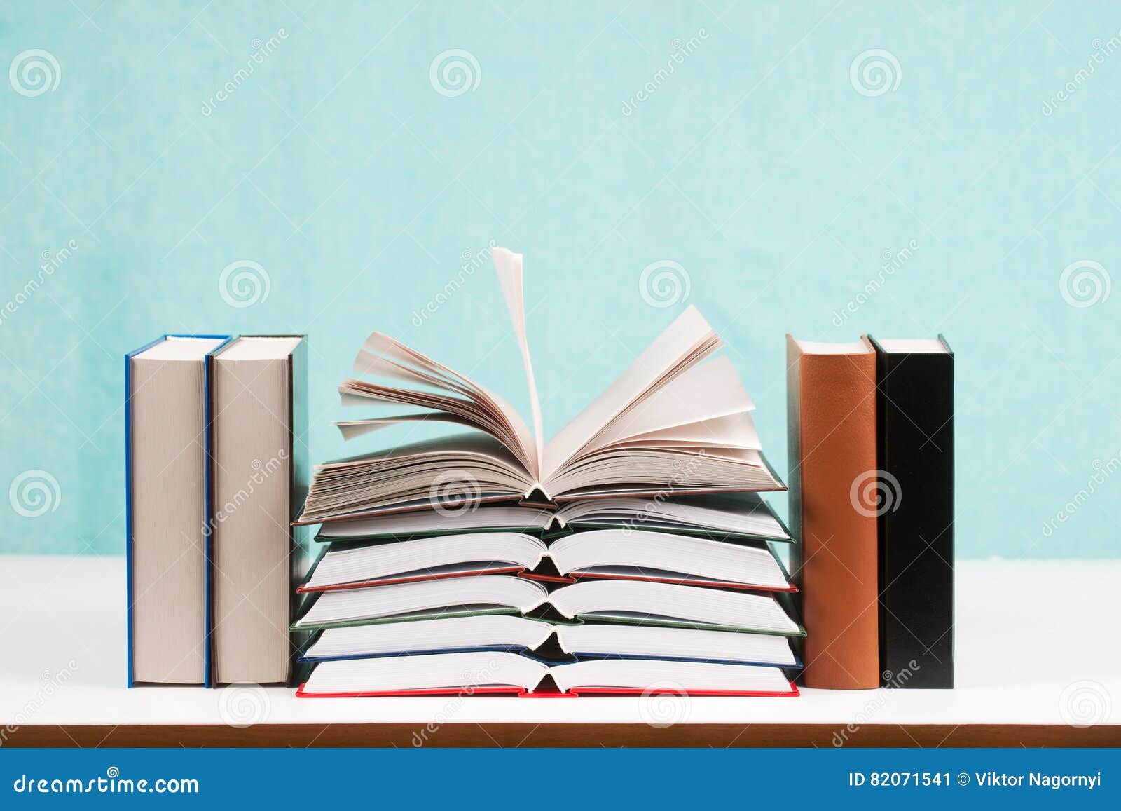 Open Book, Stack of Hardback Books on Table. Stock Image - Image of ...