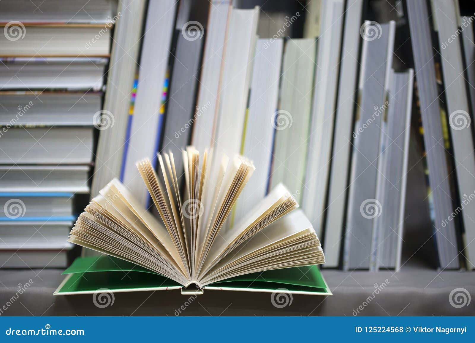 Open Book, Stack of Hardback Books on Table. Top View. Stock Photo ...