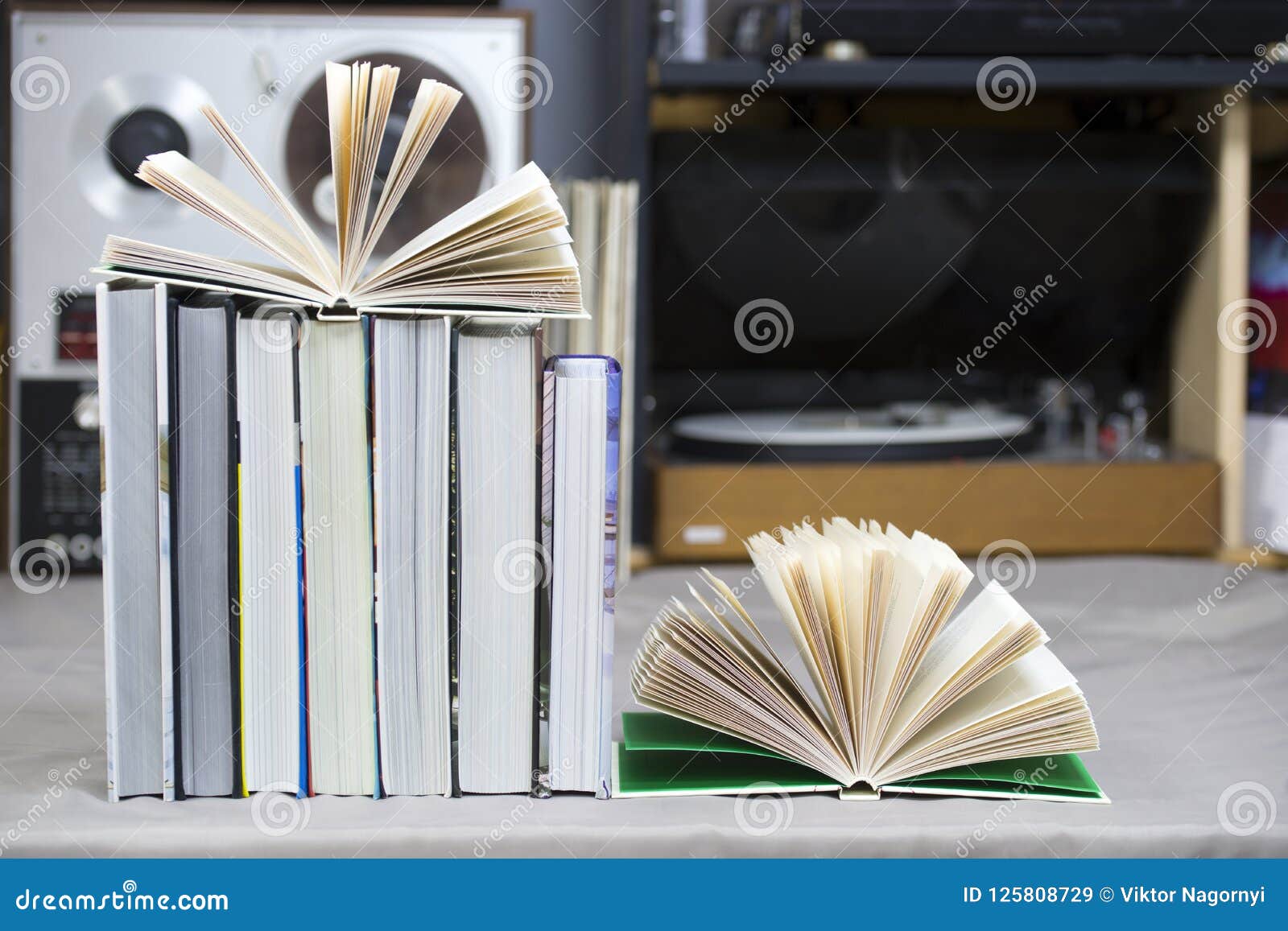 Open Book, Stack of Hardback Books on Table. Top View. Stock Image ...