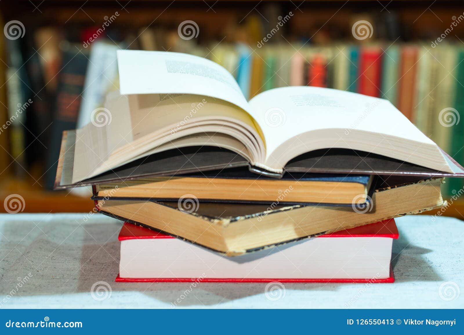 Open Book, Stack of Hardback Books on Table. Top View. Stock Image ...
