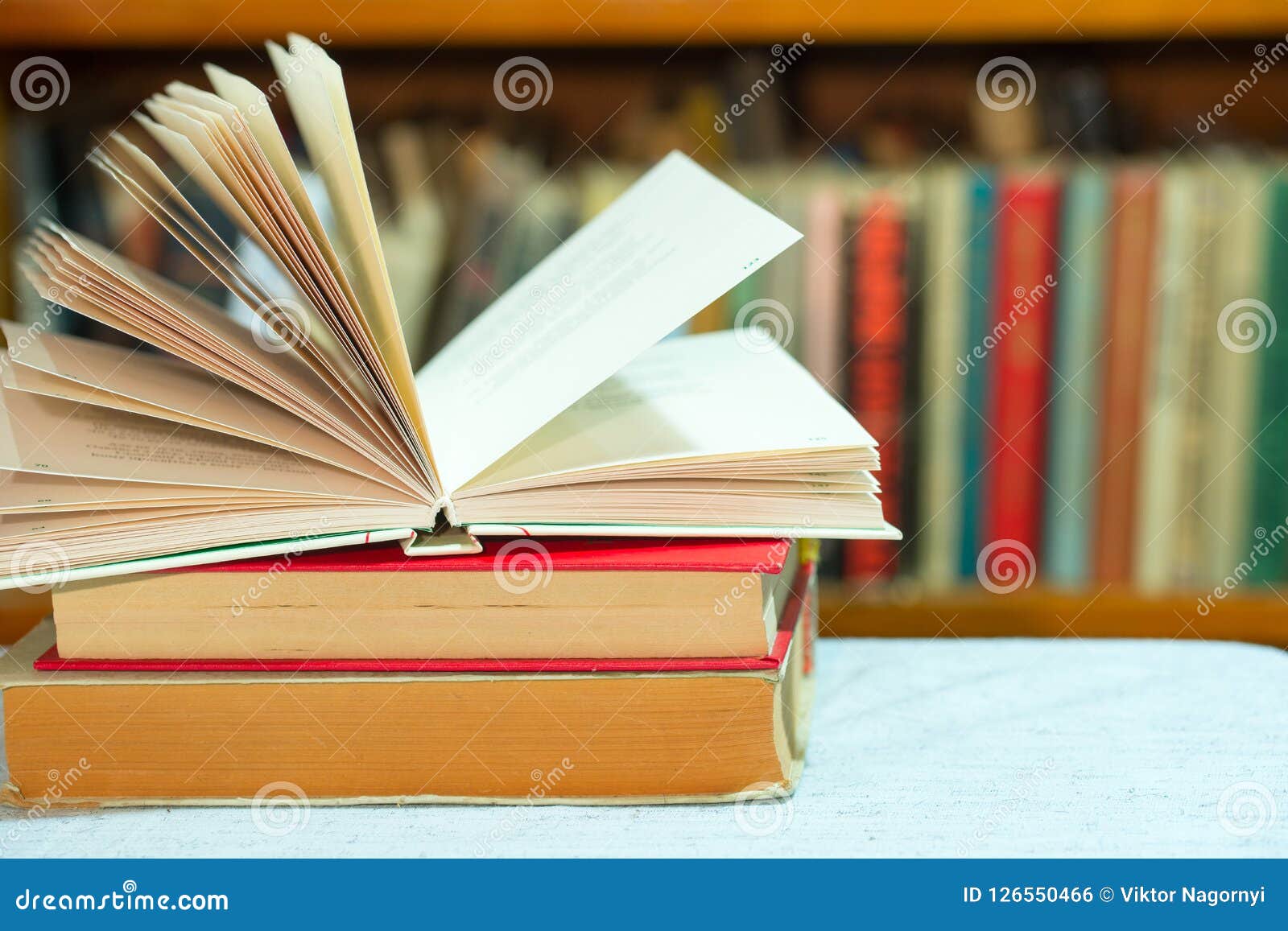 Open Book, Stack of Hardback Books on Table. Top View. Stock Photo ...