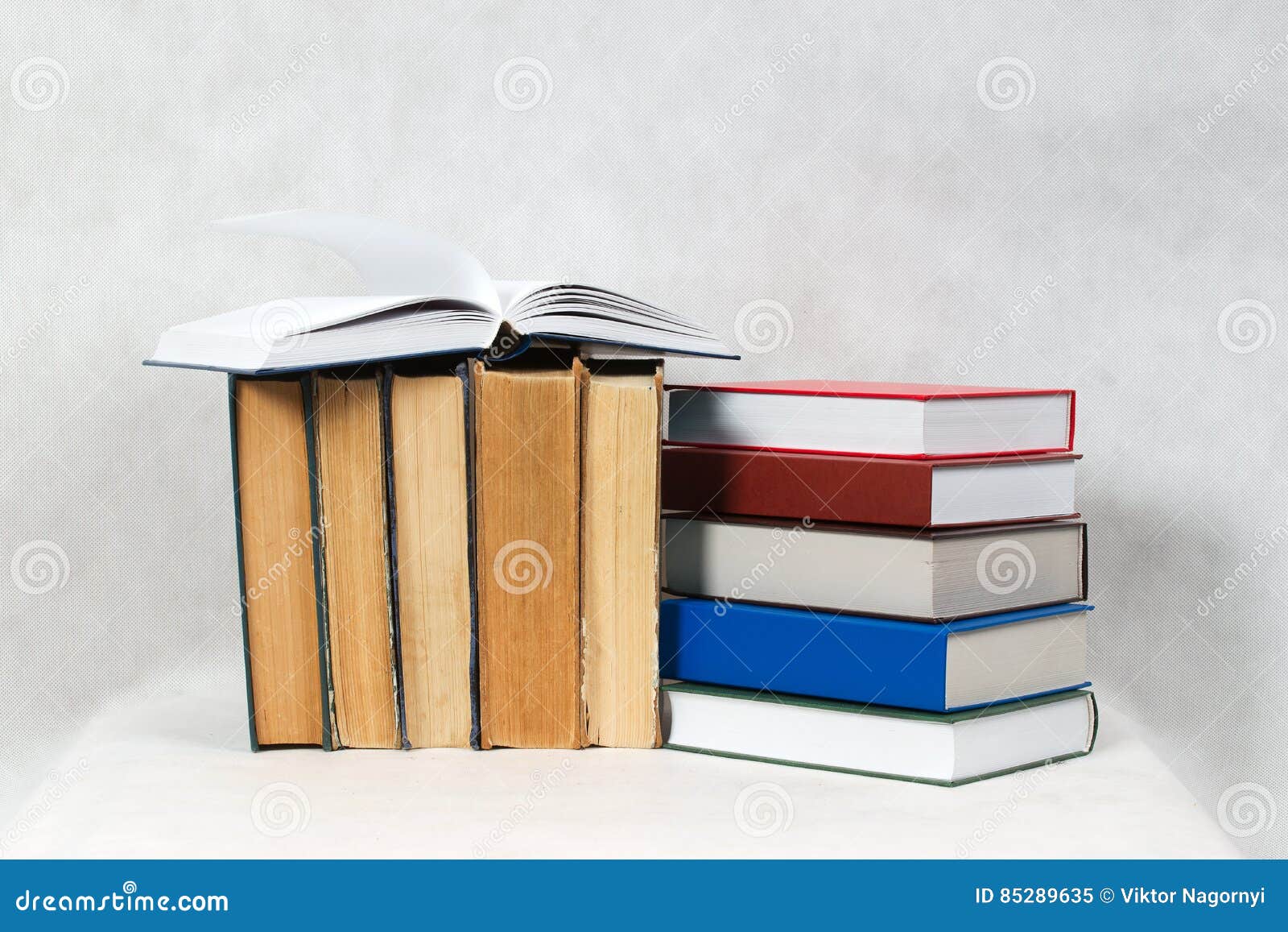 Open Book, Stack of Hardback Books on Table. Stock Image - Image of ...
