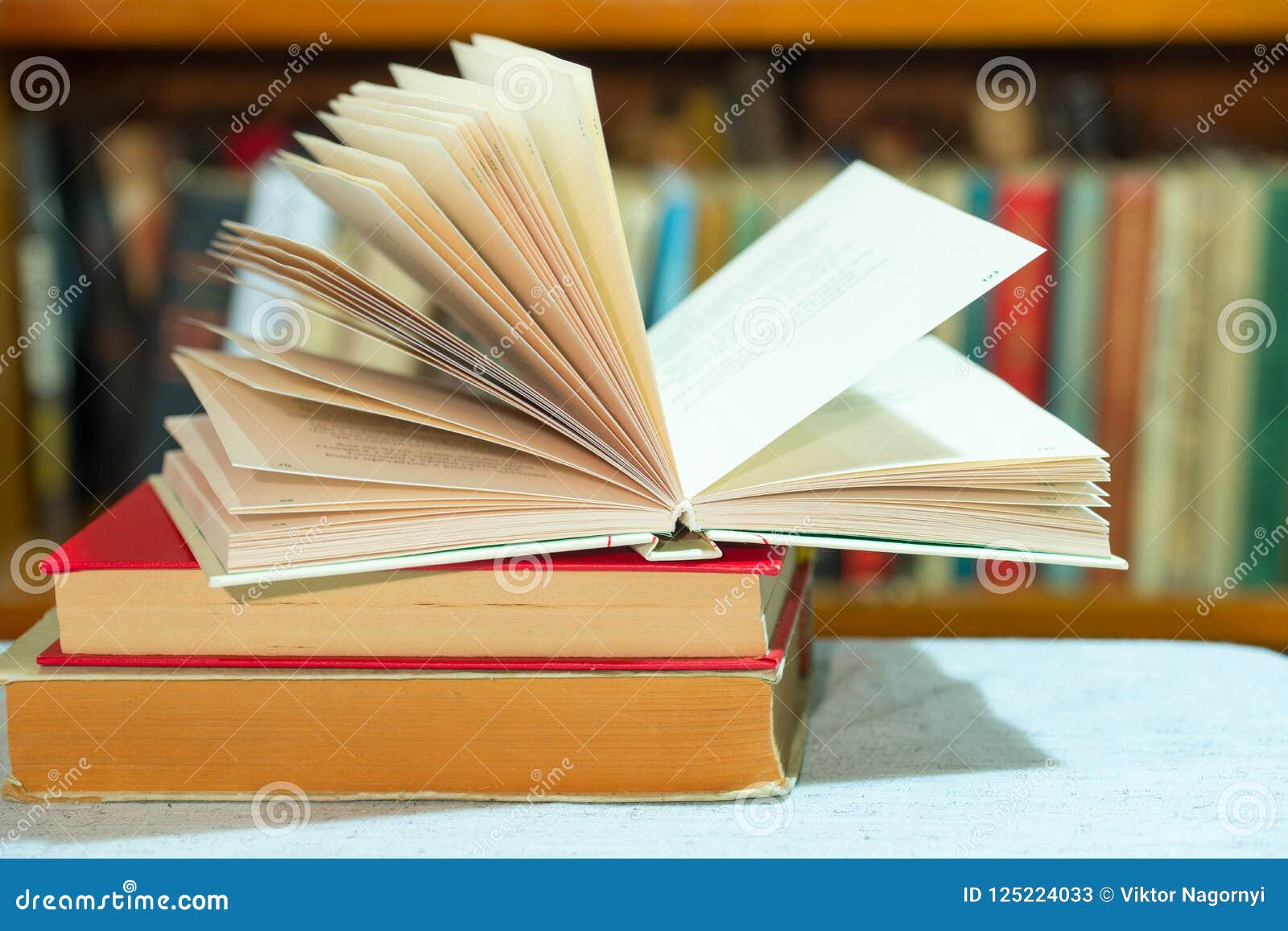 Open Book, Stack of Hardback Books on Table. Top View. Stock Image ...