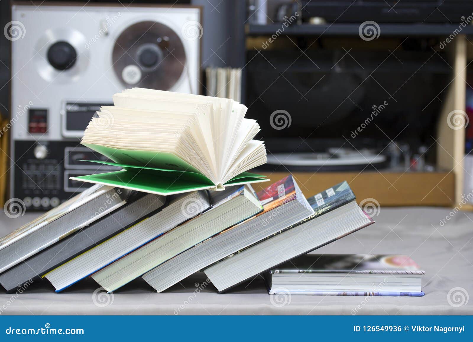 Open Book, Stack of Hardback Books on Table. Top View. Stock Photo ...