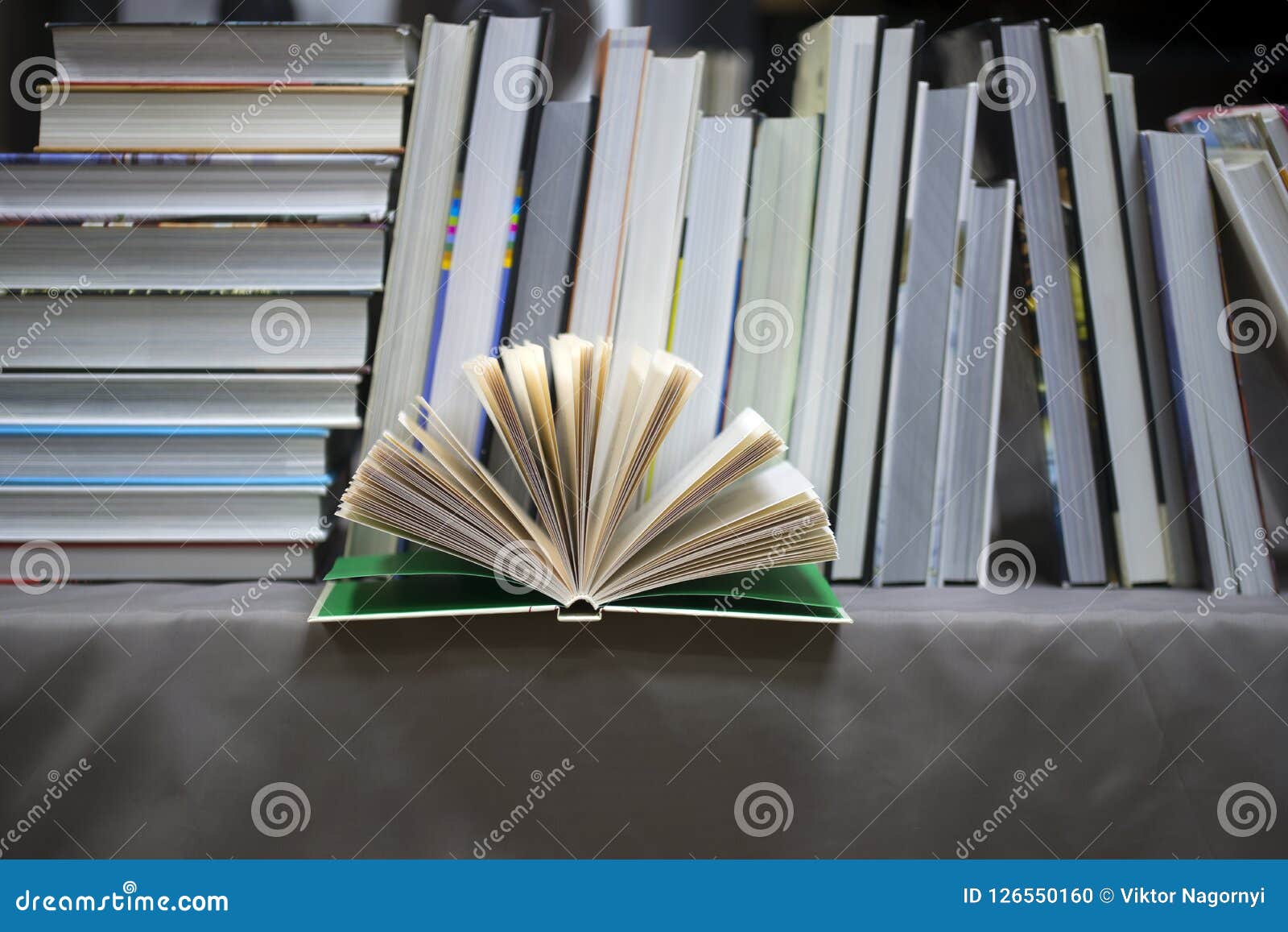 Open Book, Stack of Hardback Books on Table. Top View. Stock Photo ...