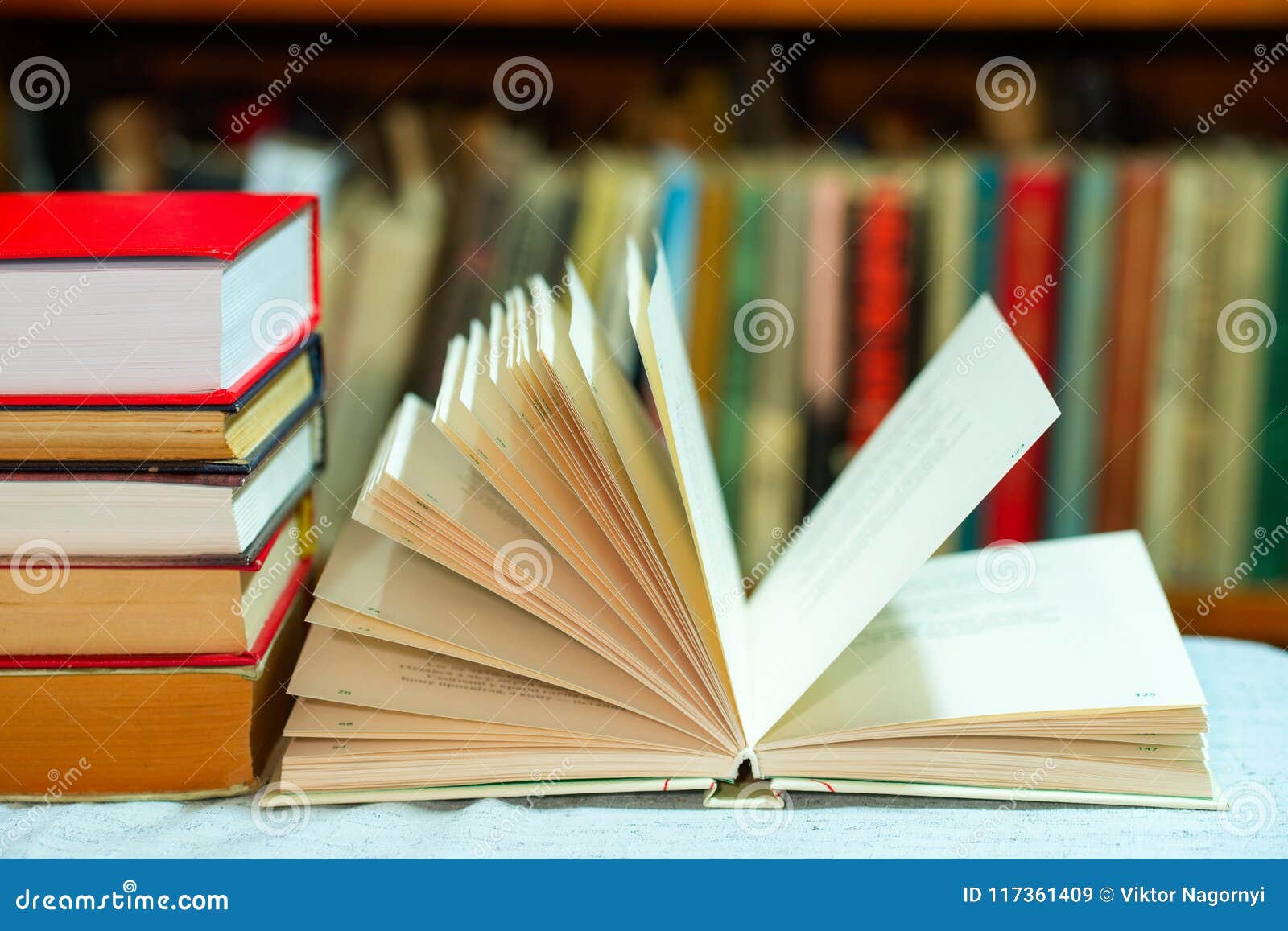 Open Book, Stack of Hardback Books on Table. Top View. Stock Image ...