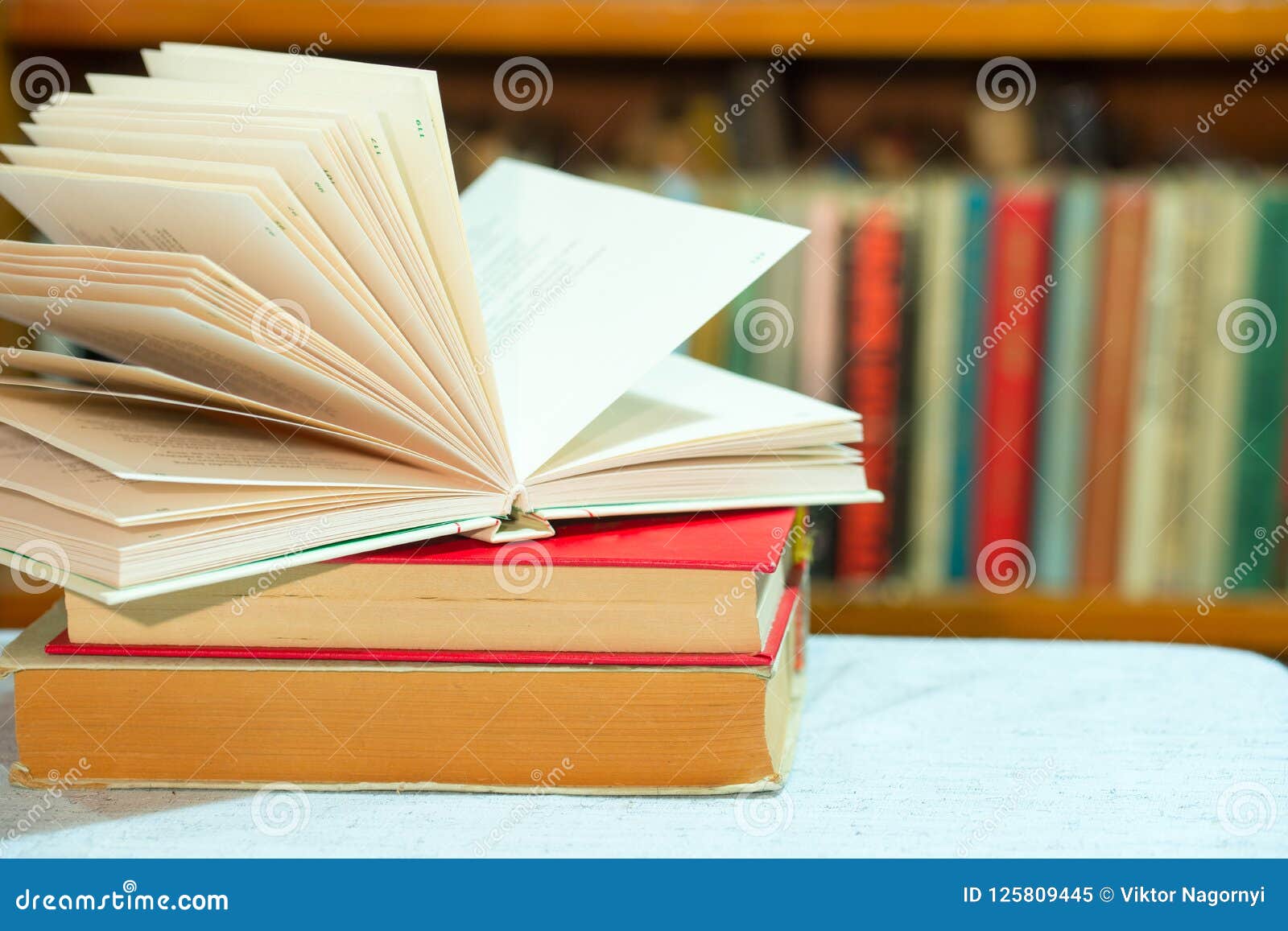 Open Book, Stack of Hardback Books on Table. Top View. Stock Image ...