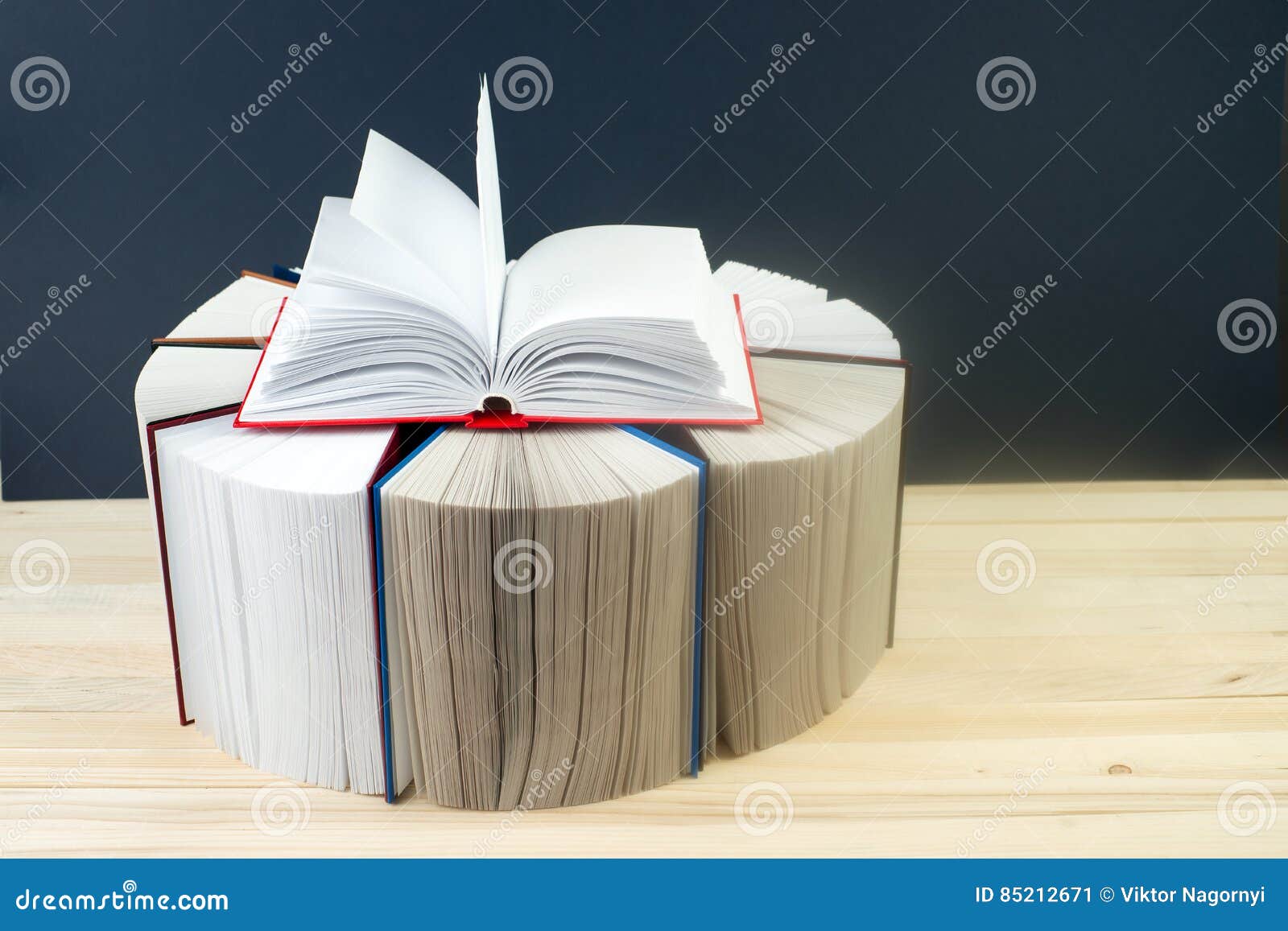 Open Book, Stack of Hardback Books on Wooden Table. Stock Image - Image ...