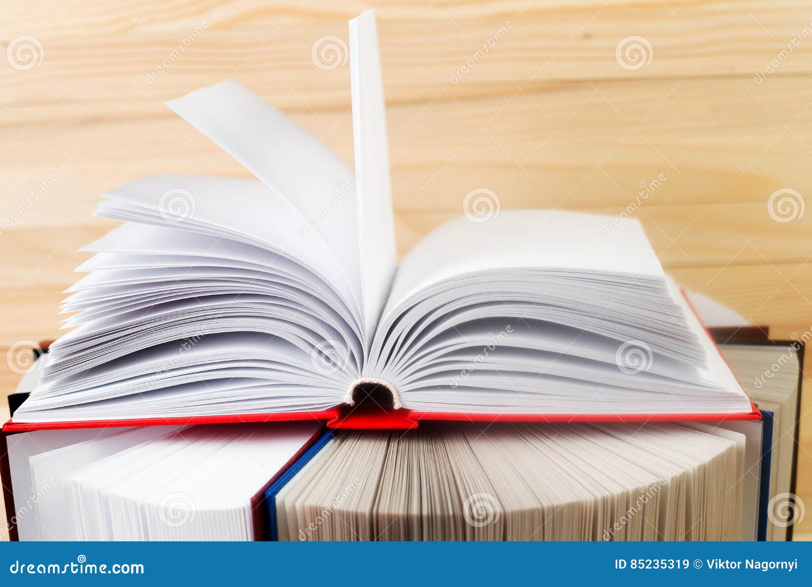 Open Book, Stack of Hardback Books on Wooden Table. Stock Image - Image ...