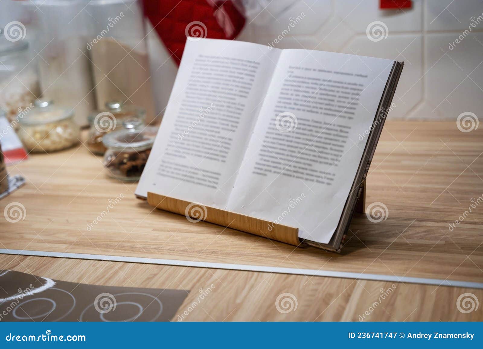 An Open Book in a Stand on the Kitchen Table, Storage Jars, Kitchen ...