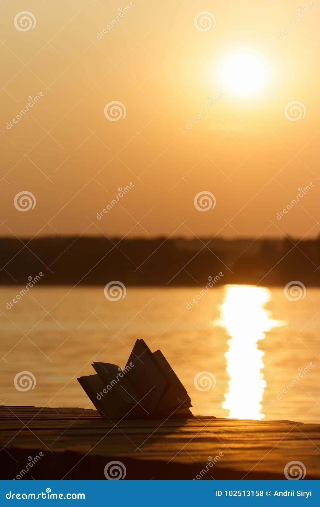 An open book at sunset stock photo. Image of vacation - 102513158