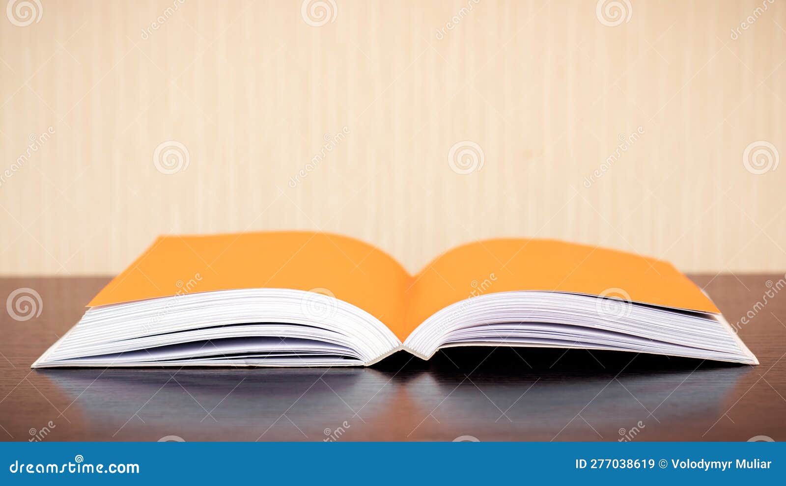 An Open Book on a Table Against the Wall, a Copy of the Space Stock ...