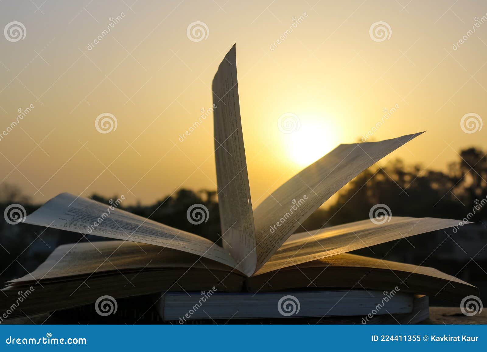 An Open Book Turning Pages Against the Sunset Sky Stock Image - Image ...