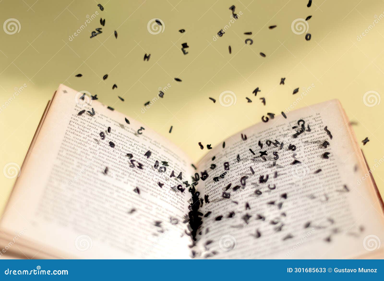 An Open Book on Which Black Letters Fall into it with a Yellow ...