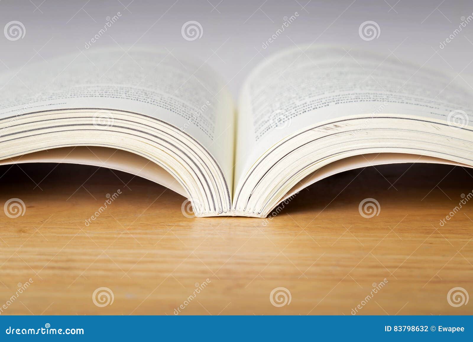 Open book on wooden table. stock photo. Image of wooden - 83798632