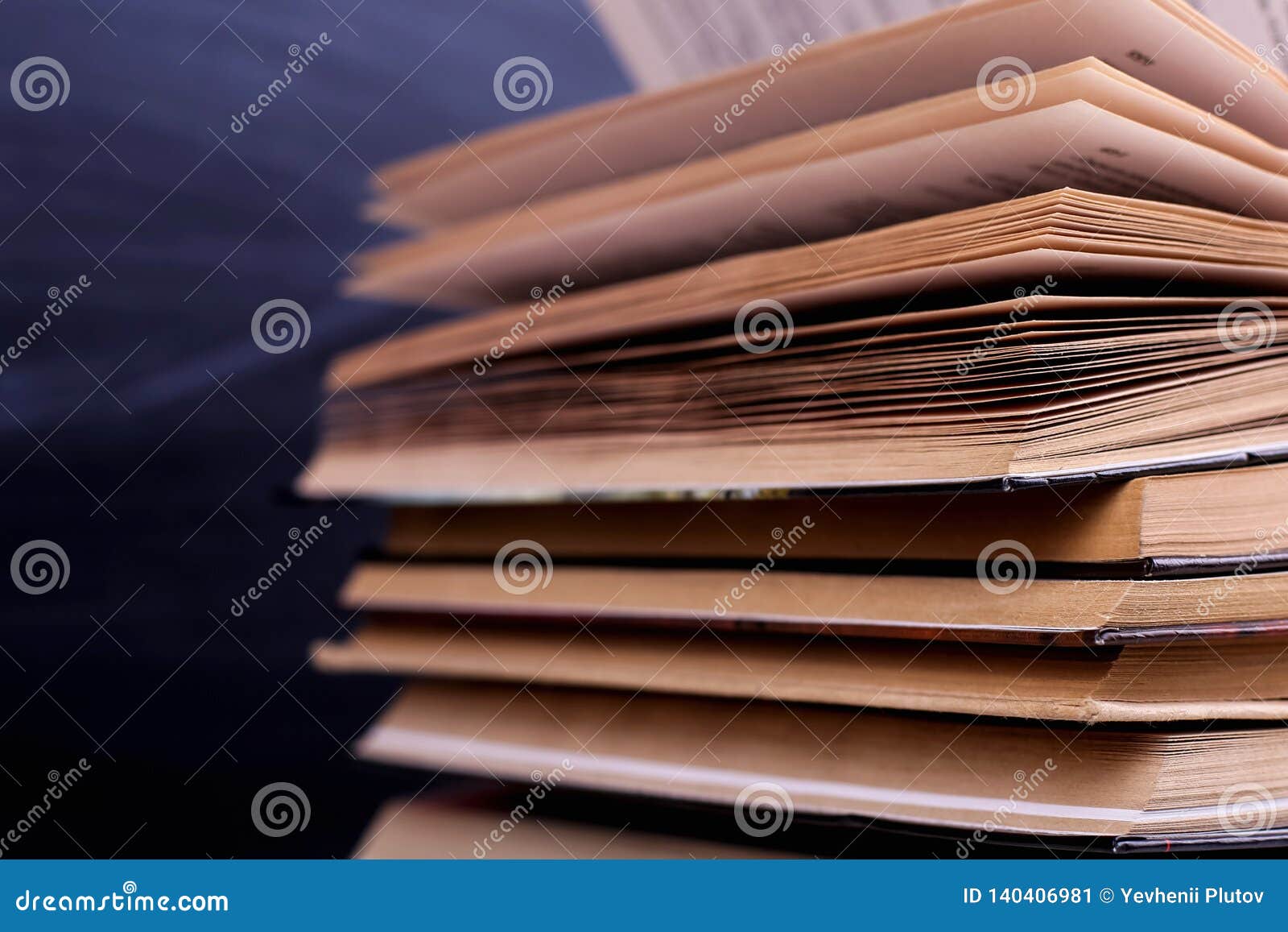 Open Books are a Stack on the Desk, Against the Background of a Chalk ...