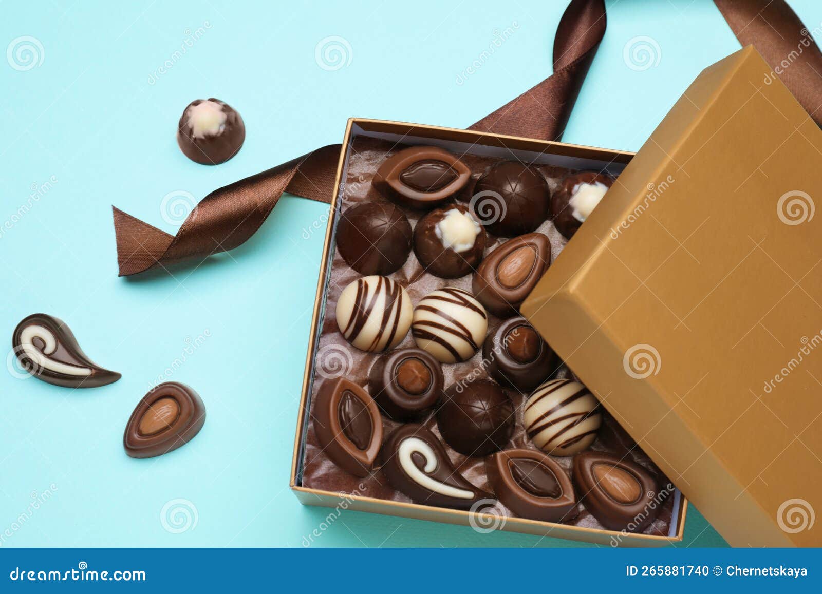 Open Box of Delicious Chocolate Candies on Light Blue Background, Flat ...