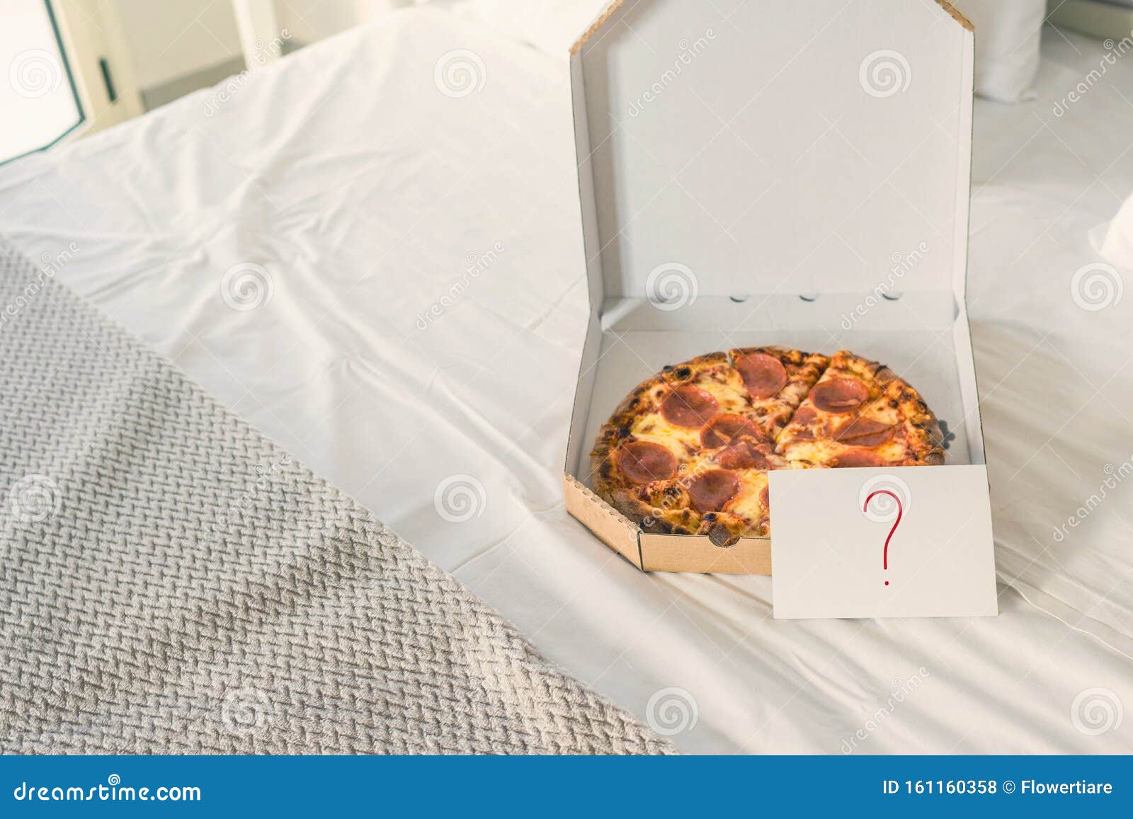 Open Box of Pizza on the Big Bed and Card with Question Mark. Stock ...