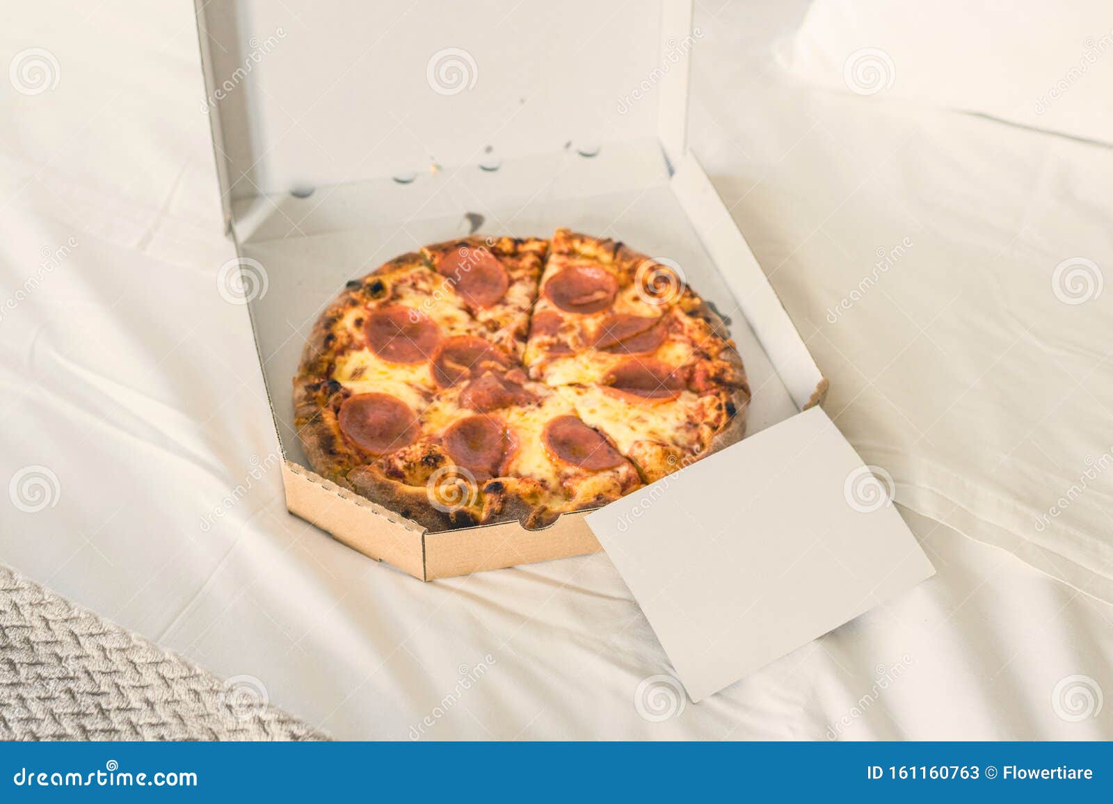 Open Box of Pizza on the Big Bed with Empty Card for Text. Concept ...