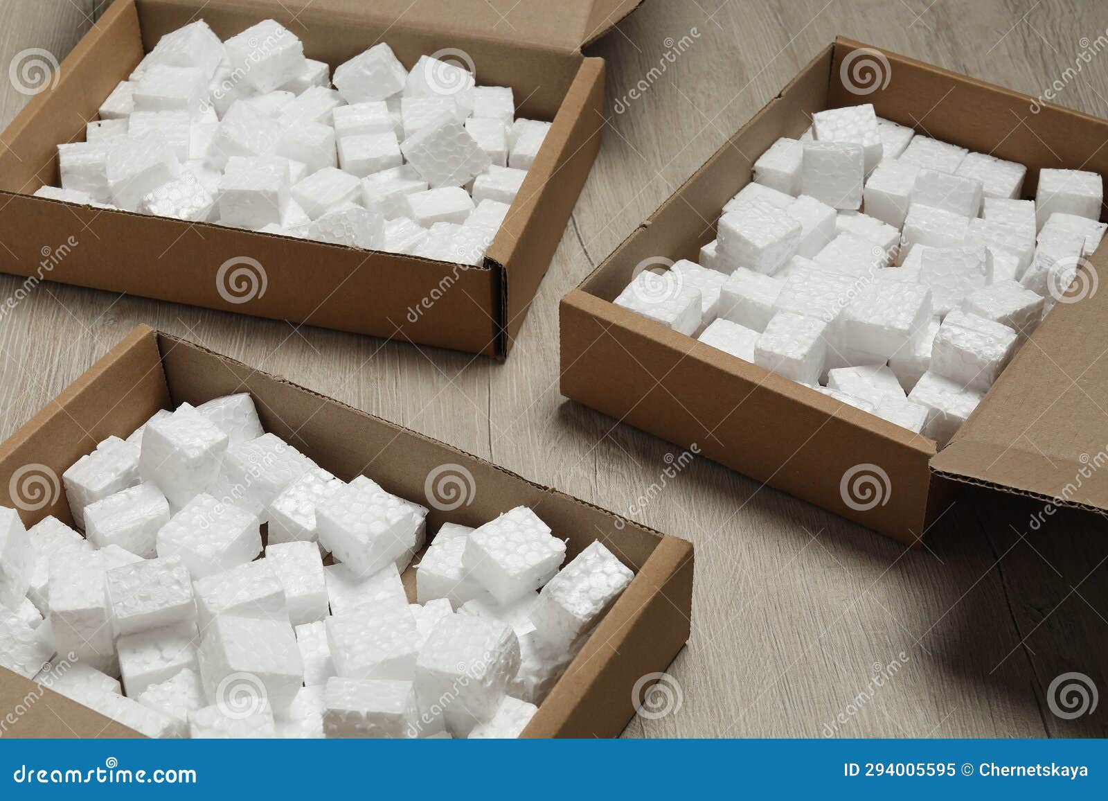 Open Cardboard Boxes with Pieces of Polystyrene Foam on Wooden Floor ...