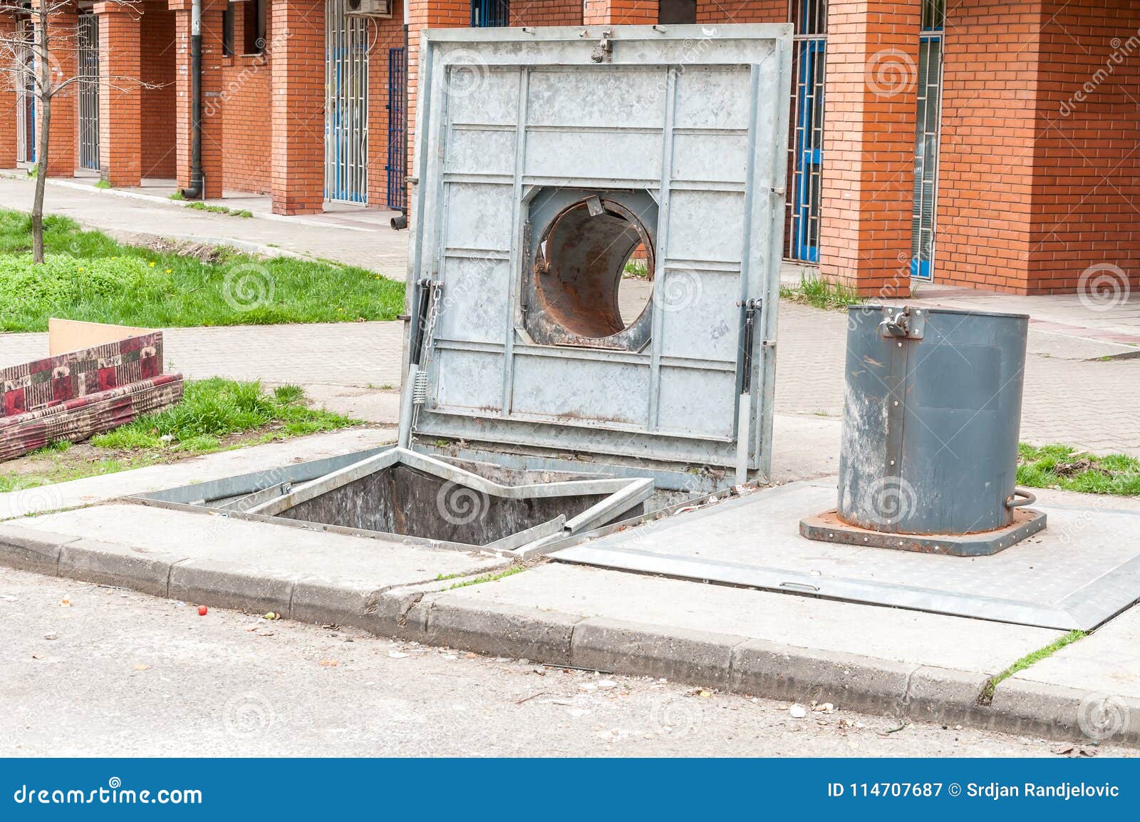 Open Cover of an Underground Garbage Container on the Street in the ...