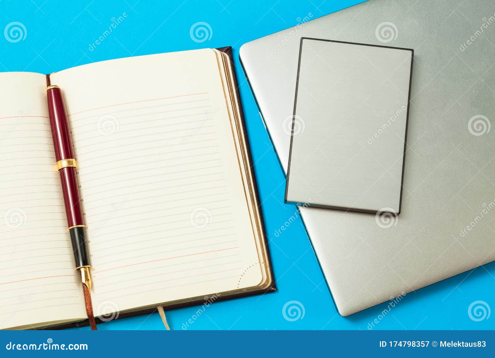 Open Diary and Laptop on a Blue Background Stock Image - Image of ...