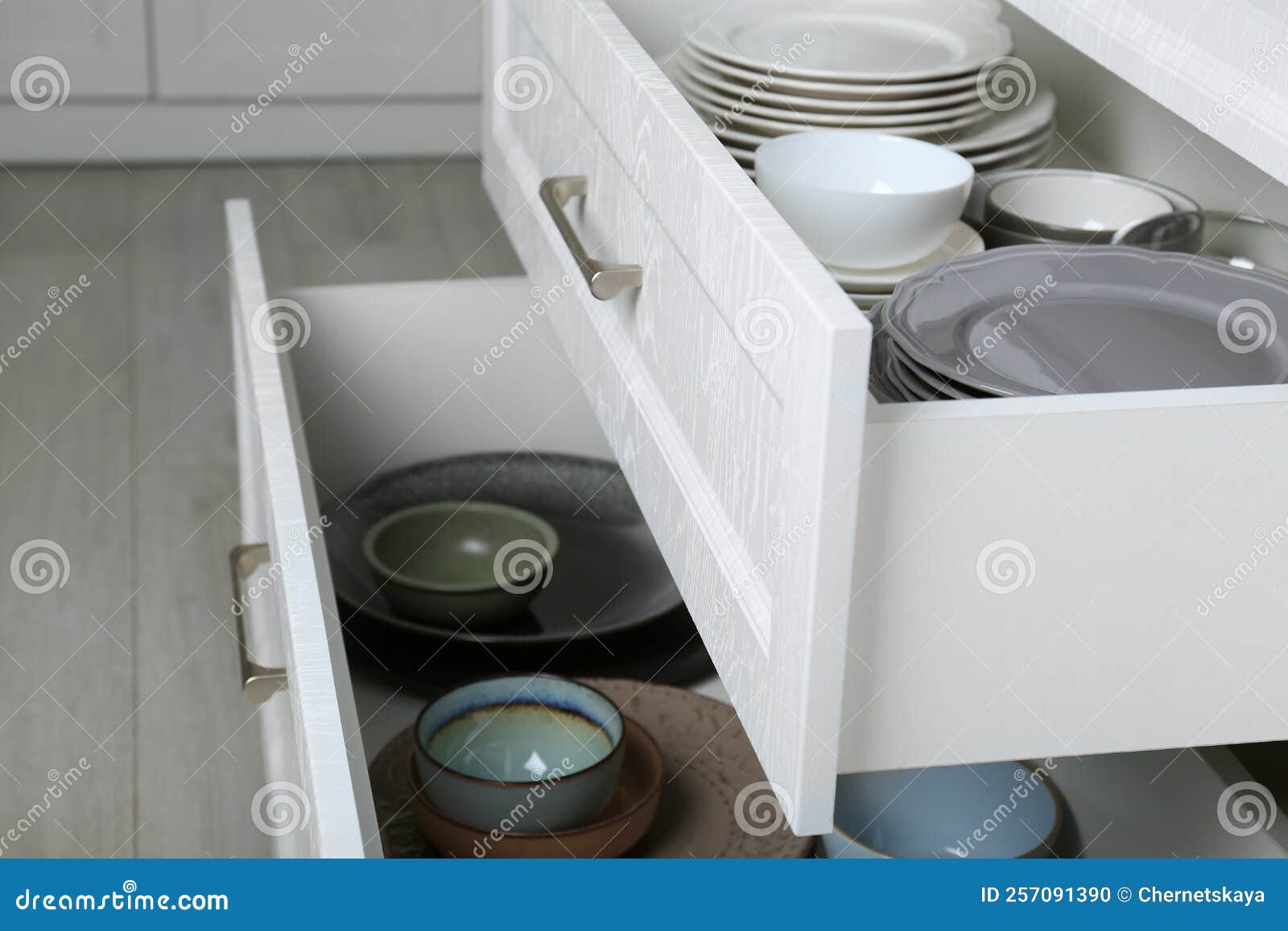 Open Drawers with Different Plates and Bowls in Kitchen, Closeup Stock ...