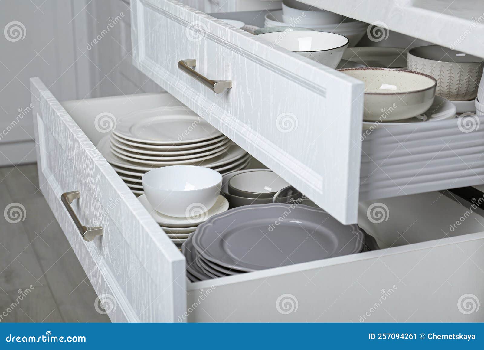 Open Drawers with Different Plates and Bowls in Kitchen, Closeup Stock ...