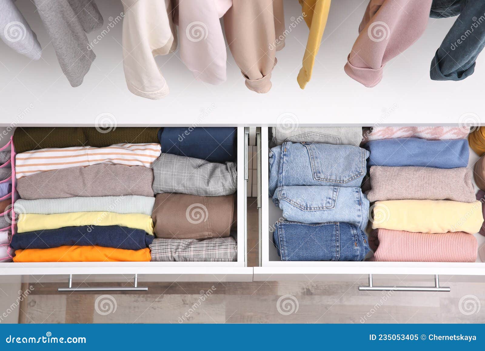 Open Drawers with Folded Clothes Indoors, Top View. Vertical Storage ...