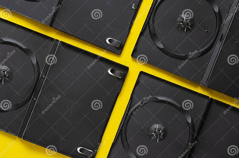 Open Empty DVD Boxes on a Yellow Background Stock Photo - Image of ...