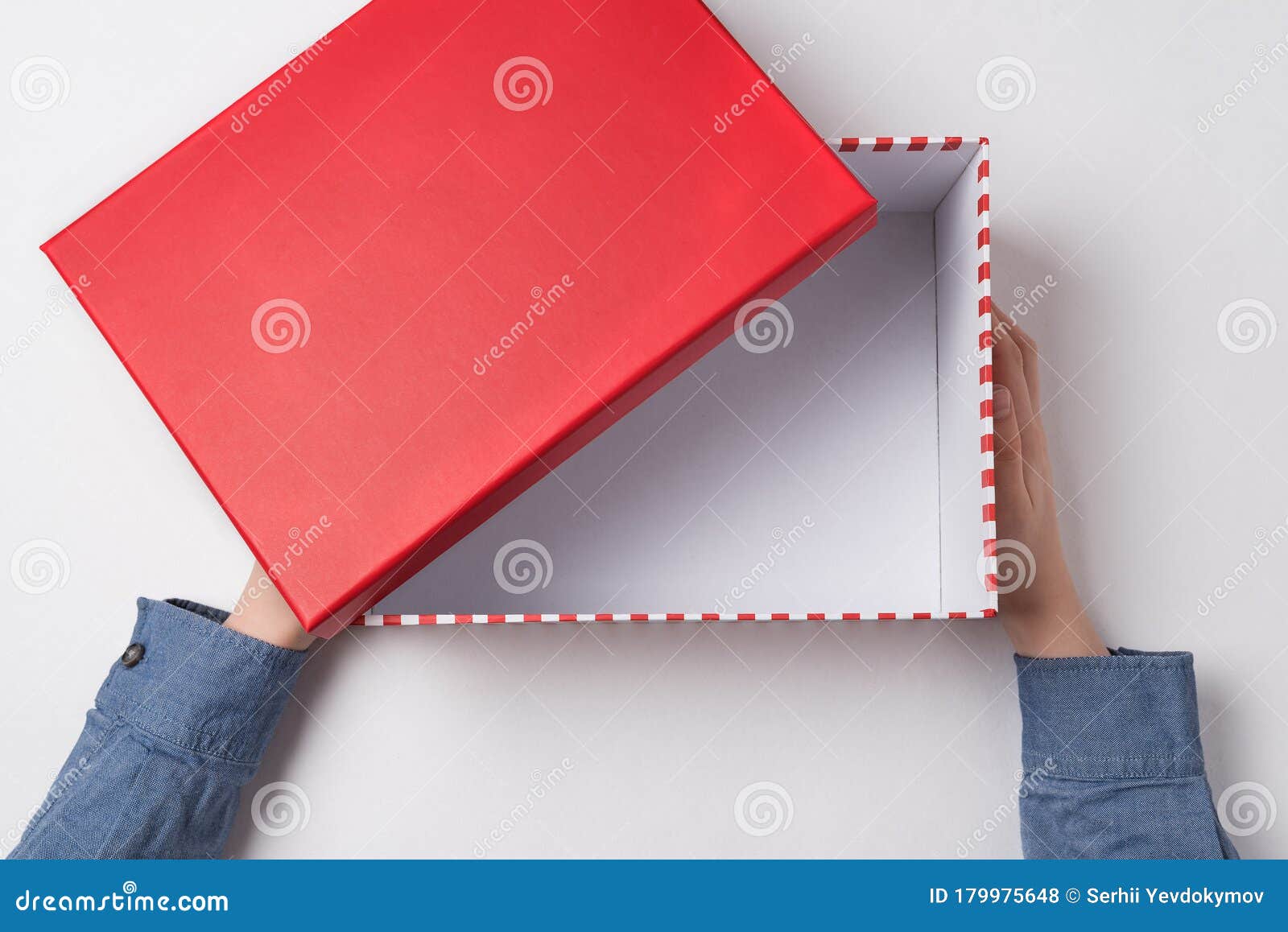Open Empty Red Box in Children`s Hands on White Background. Top View ...