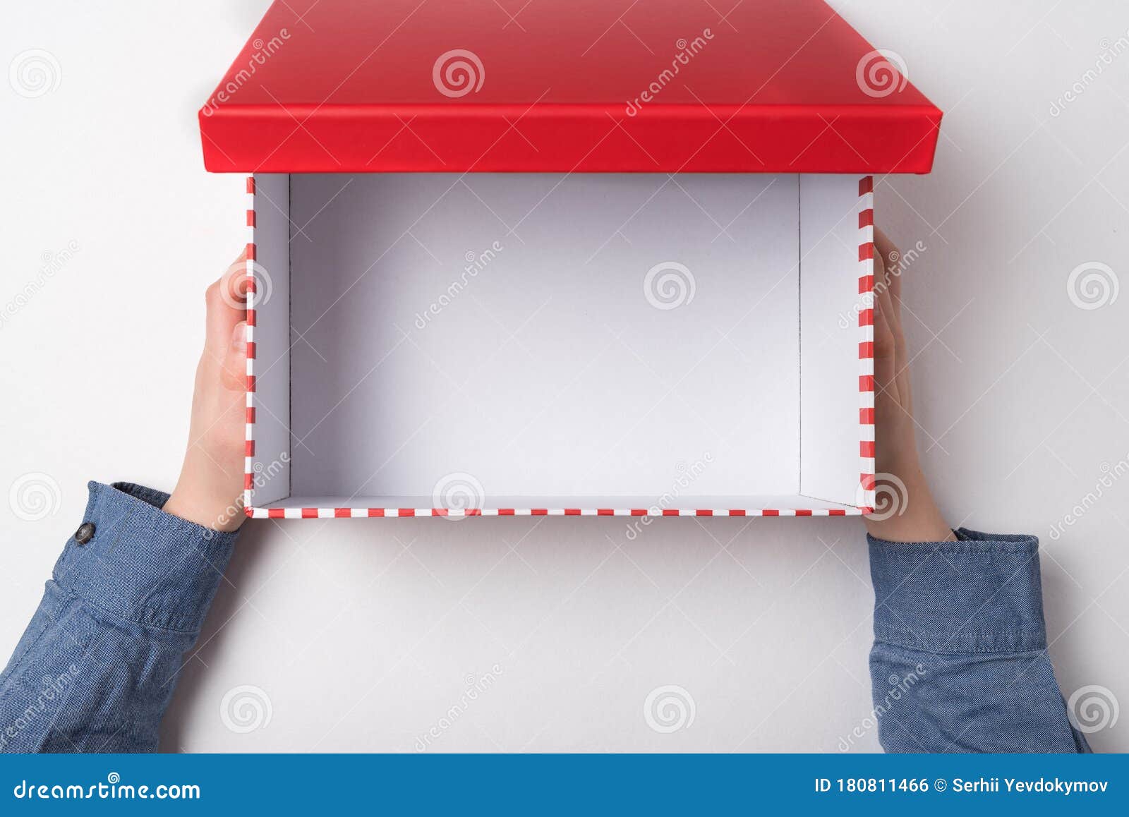 Open Empty Red Box in Children`s Hands on White Background. Top View ...