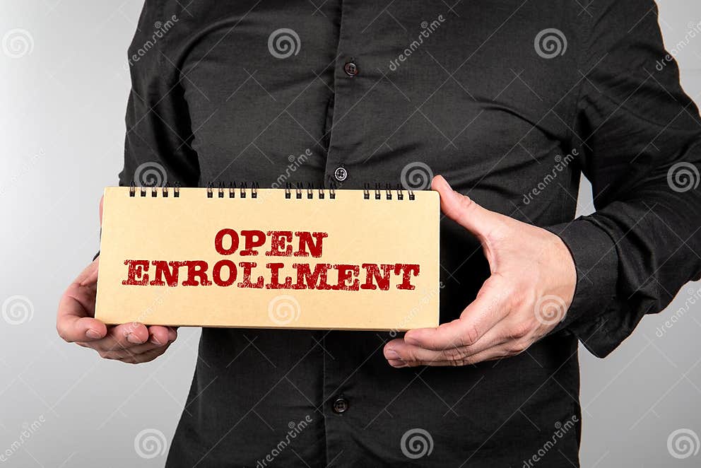 Open Enrollment. Business Man with Notepad on a Light Background Stock ...