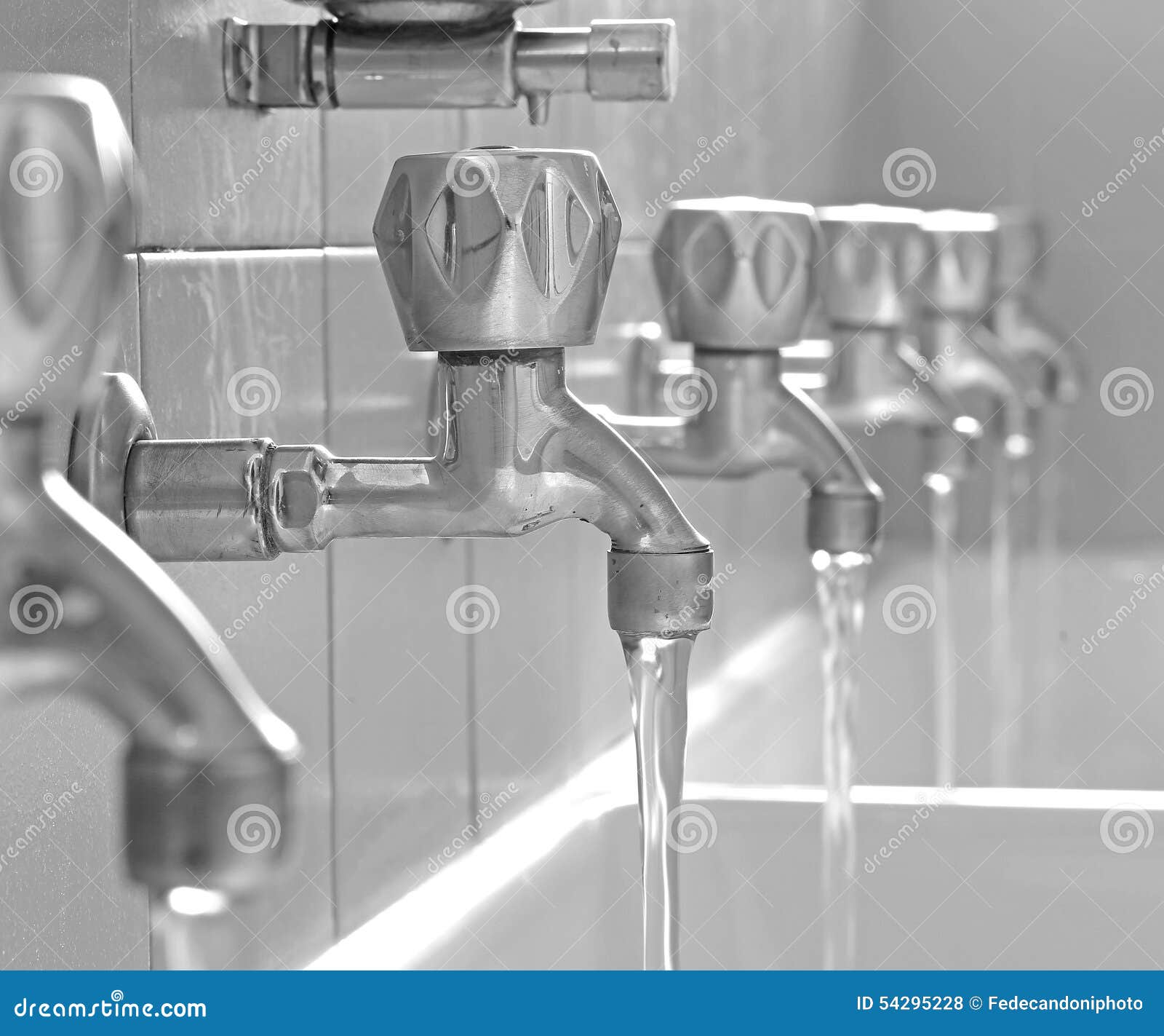 Open Faucets with Water Flowing in the Bath Changing Rooms Stock Photo ...