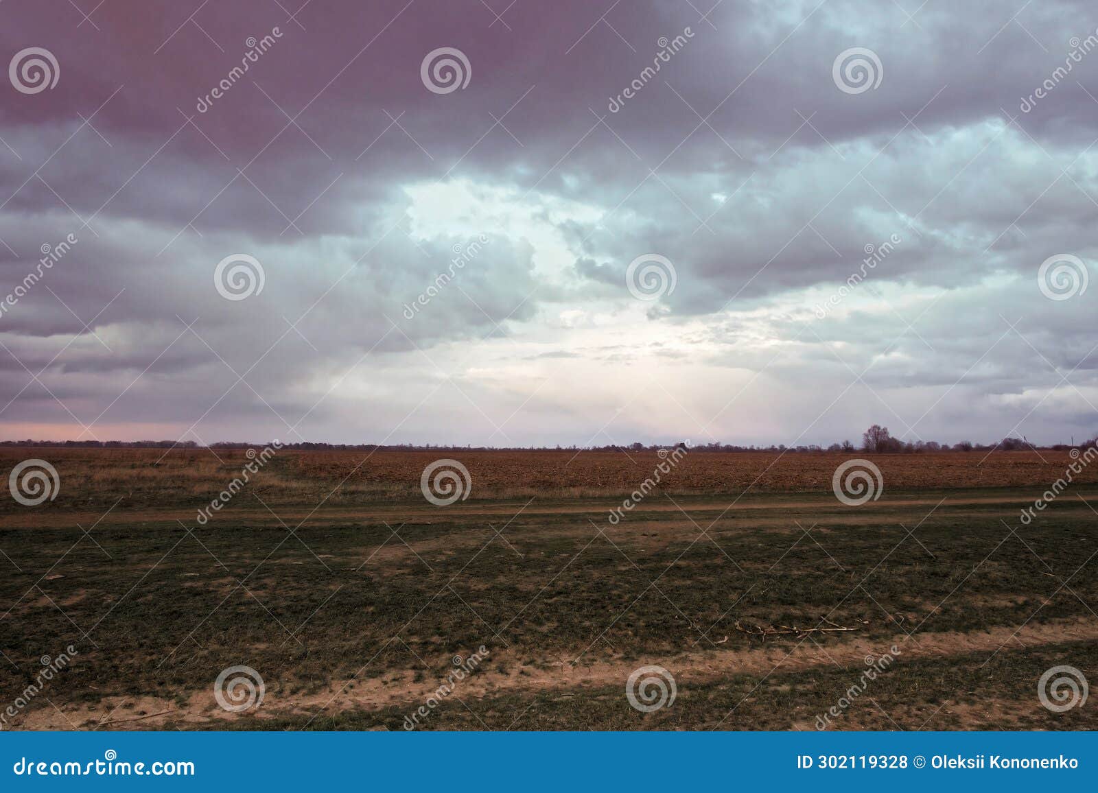 An Open Field with Dark Clouds Gathering Above Stock Photo - Image of ...