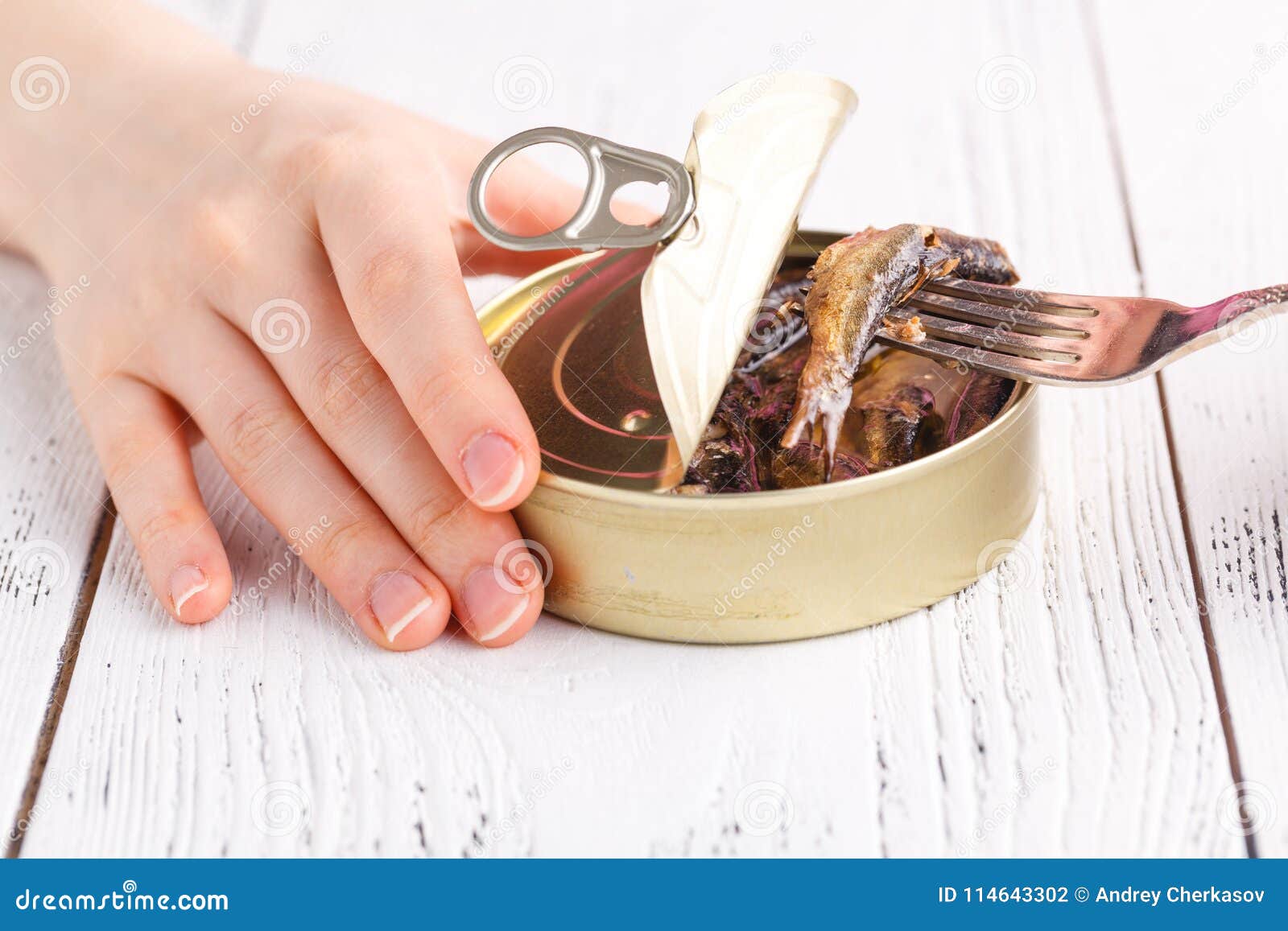 Open Fish Can with Hands and Fork on Table Stock Photo - Image of fork ...