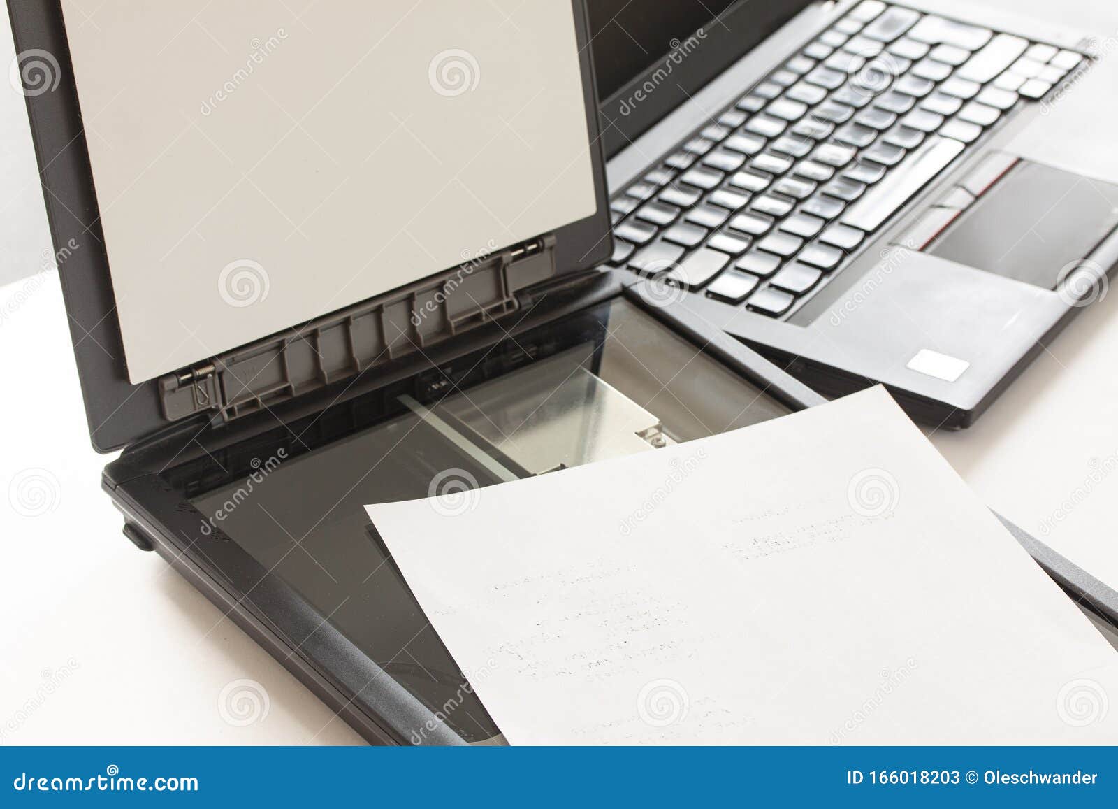 Open Flatbed Scanner with Paper Lying on it and a Notebook Computer in ...