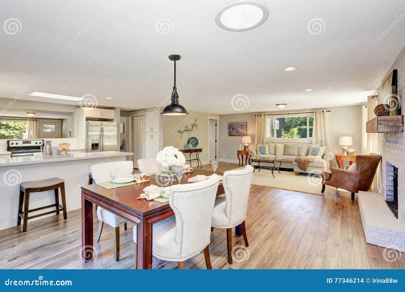 Open Floor Plan Dining Area with Elegant Table Setting and White Soft ...