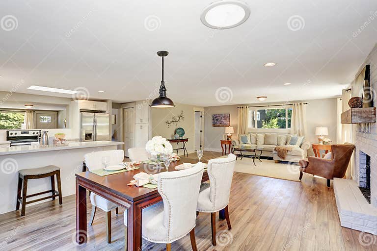 Open Floor Plan Dining Area with Elegant Table Setting and White Soft ...