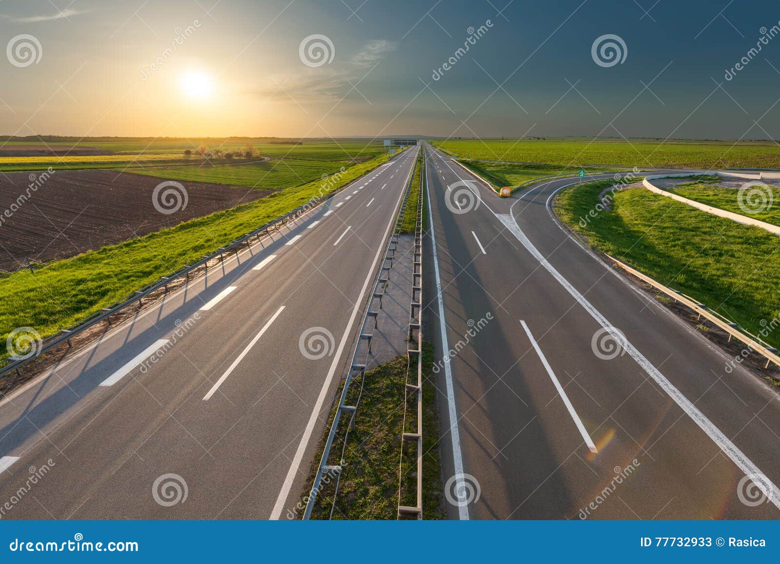 Open Freeway through Illuminated Green Idyllic Fields Stock Image ...